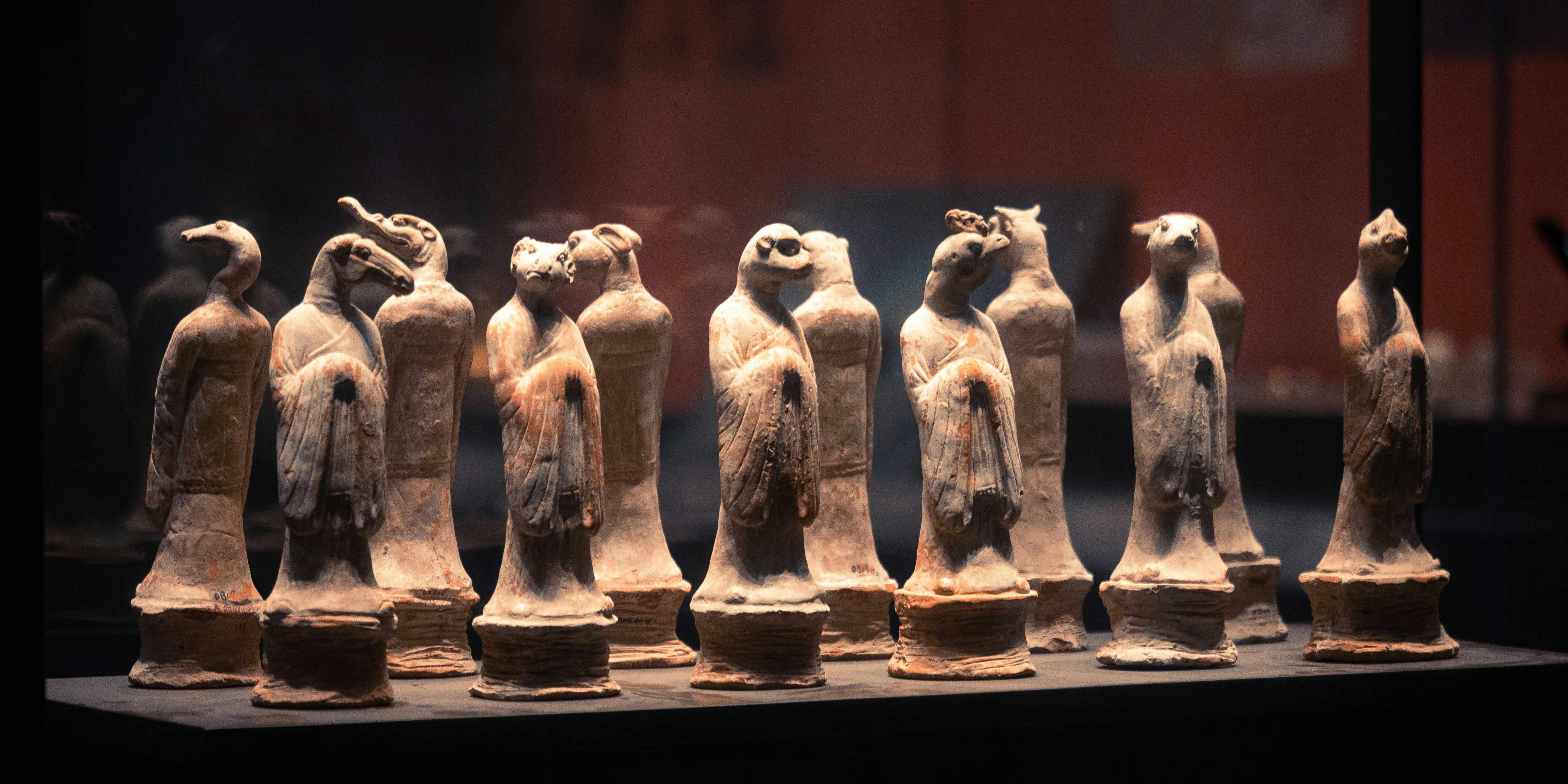 Ancient pottery statues are displayed in a museum. photo – Free Human ...