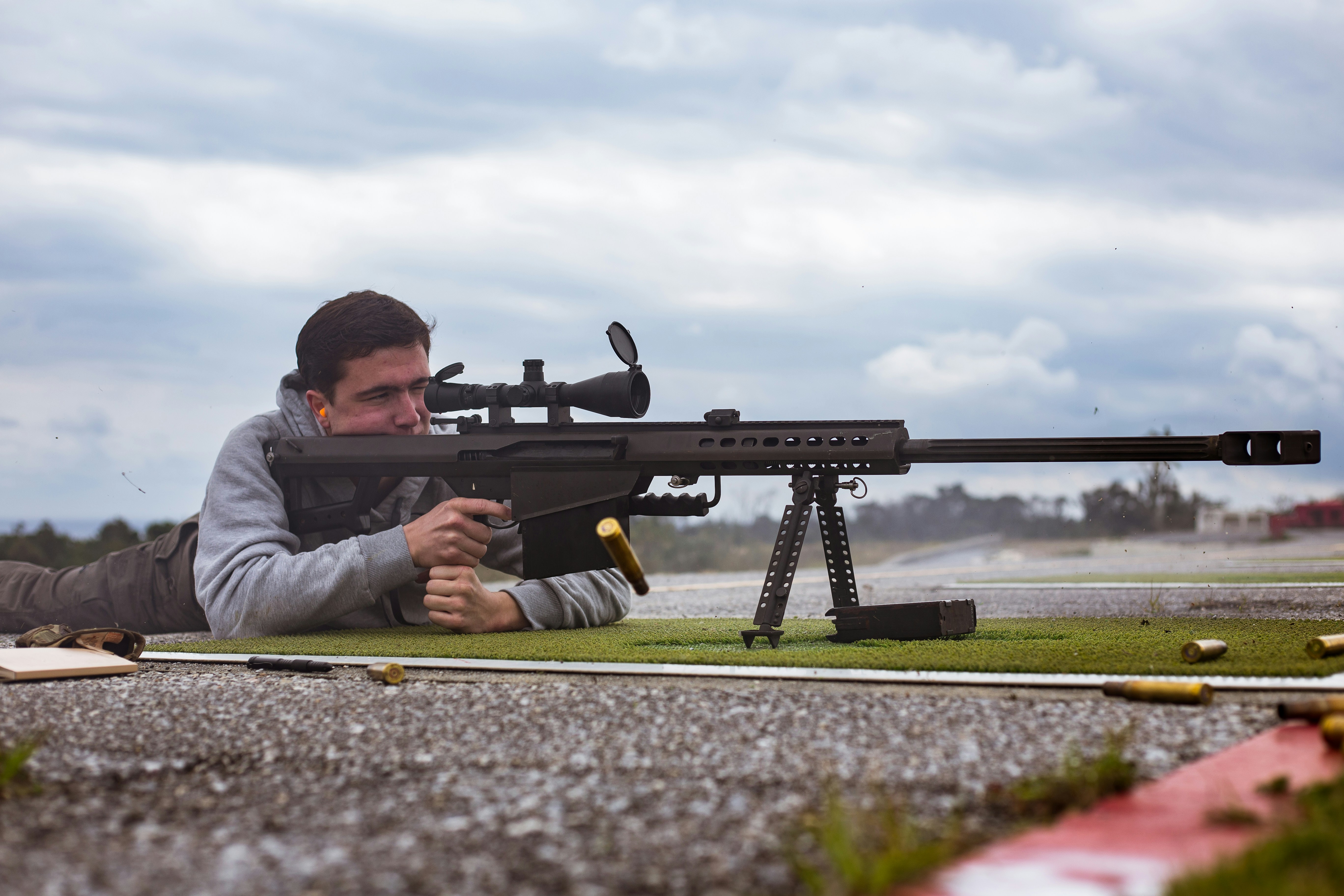 A man is using a high-powered sniper rifle. photo – Free Sniper Image ...