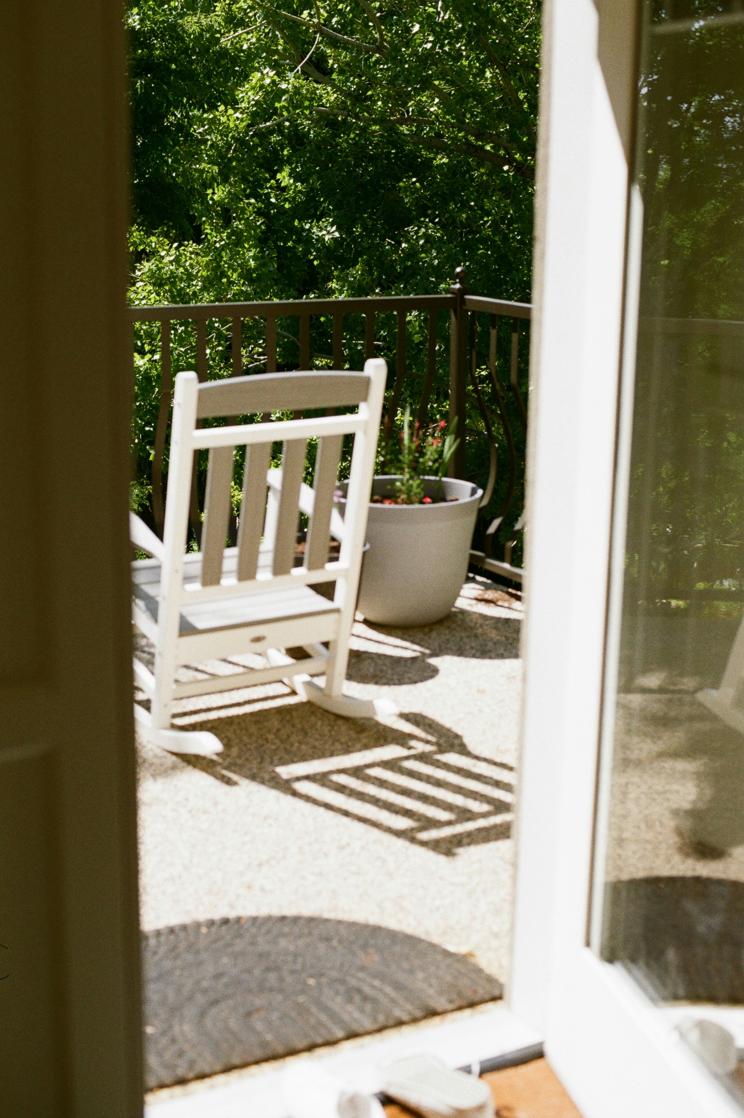 A rocking chair sits on a sunny balcony. photo – Free Film photography ...