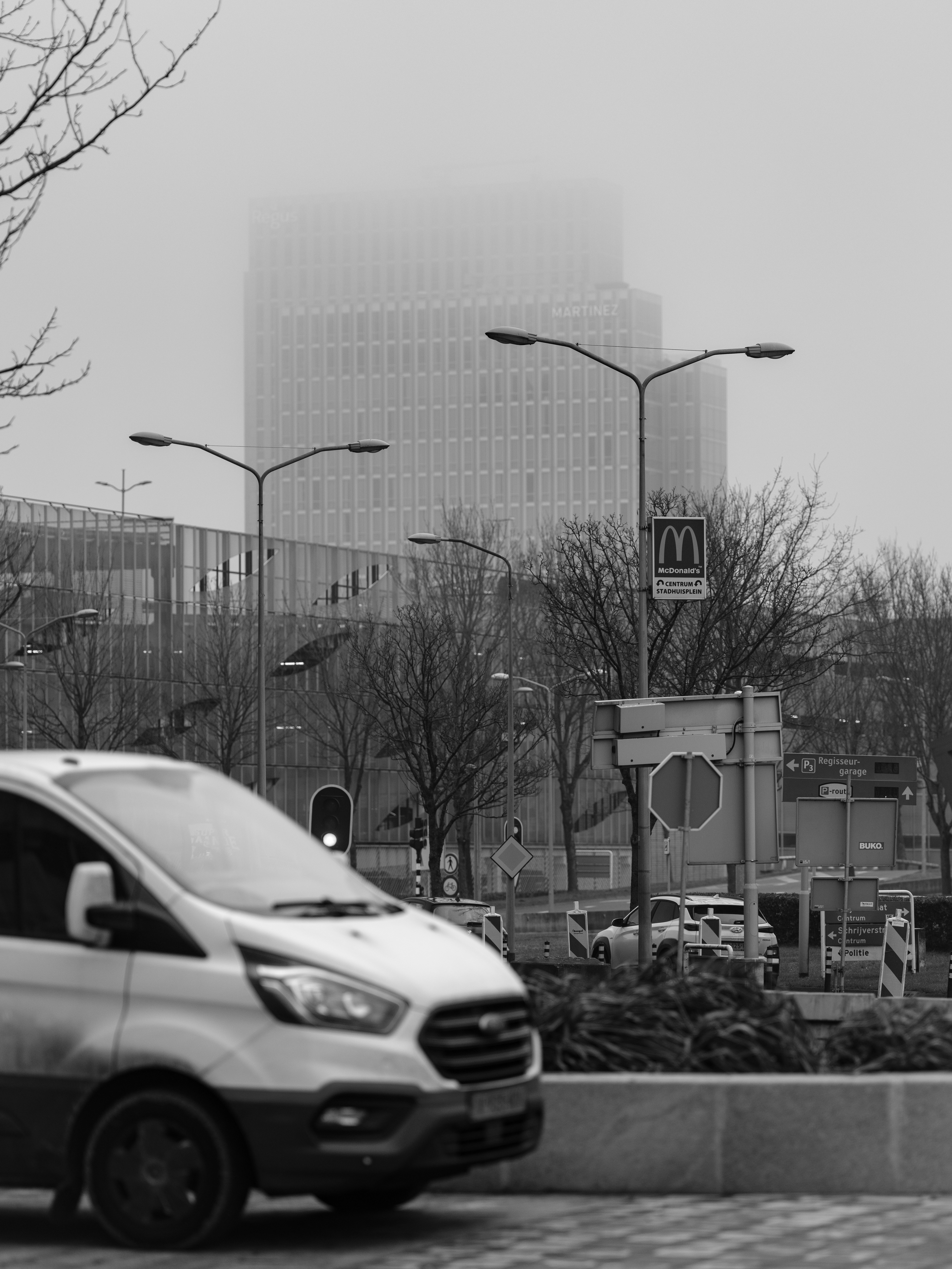 Fog-Blanketed Boulevard: A White Van Anchors the City Line