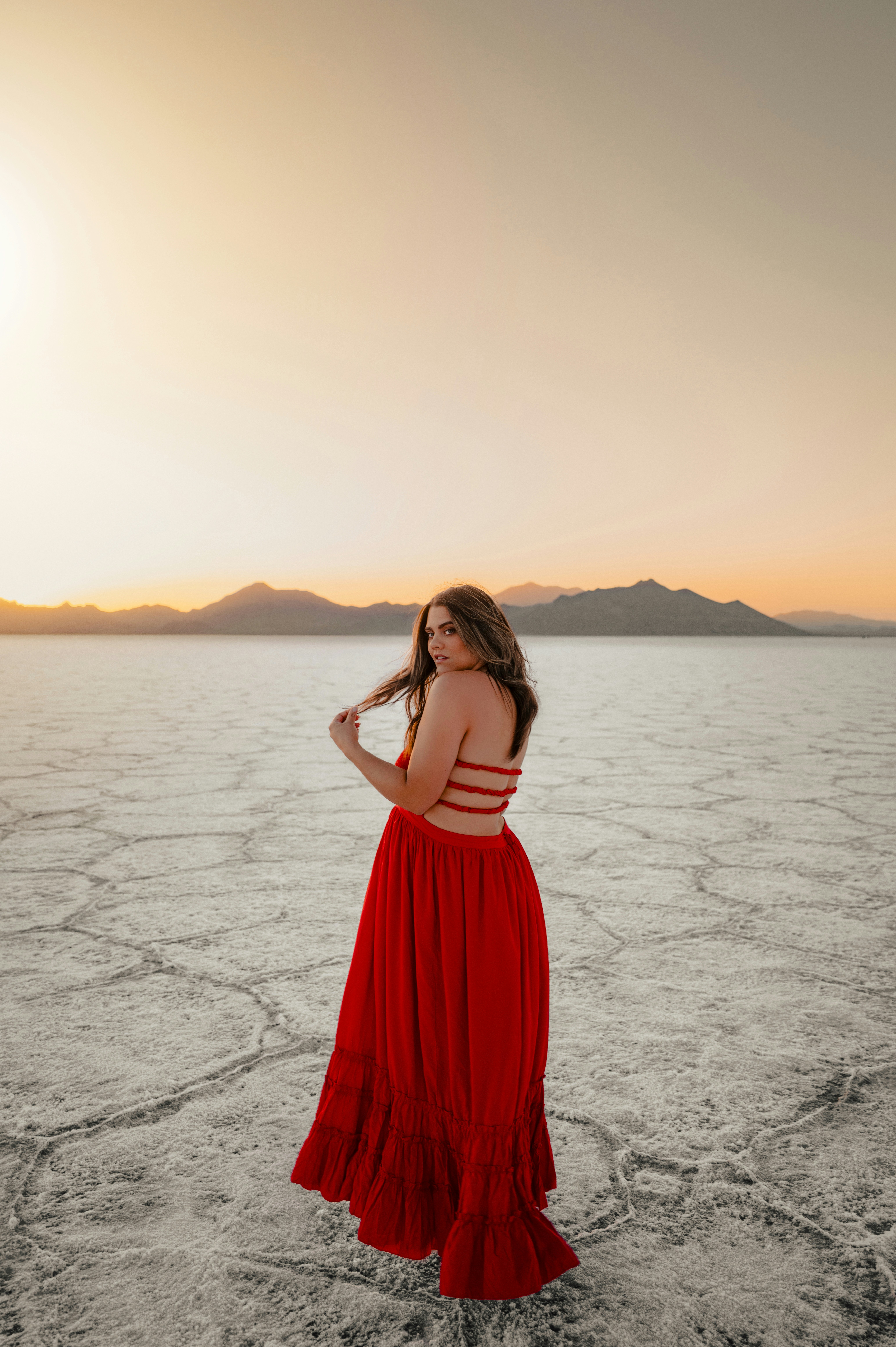 A woman poses in a red dress at sunset. photo – Free Woman Image on ...