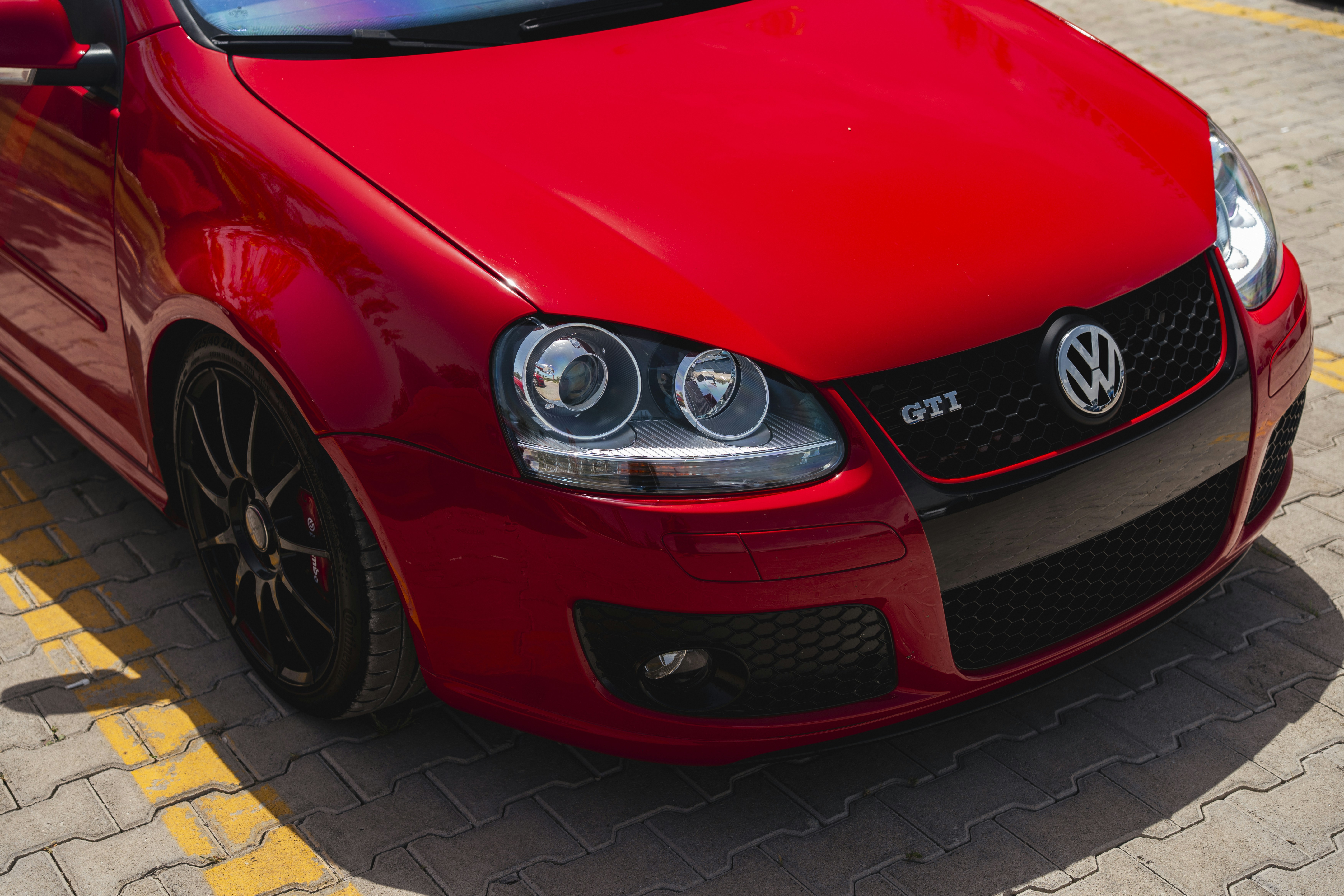 A red volkswagen gti sits on display. photo – Free Wallpaper Image on ...