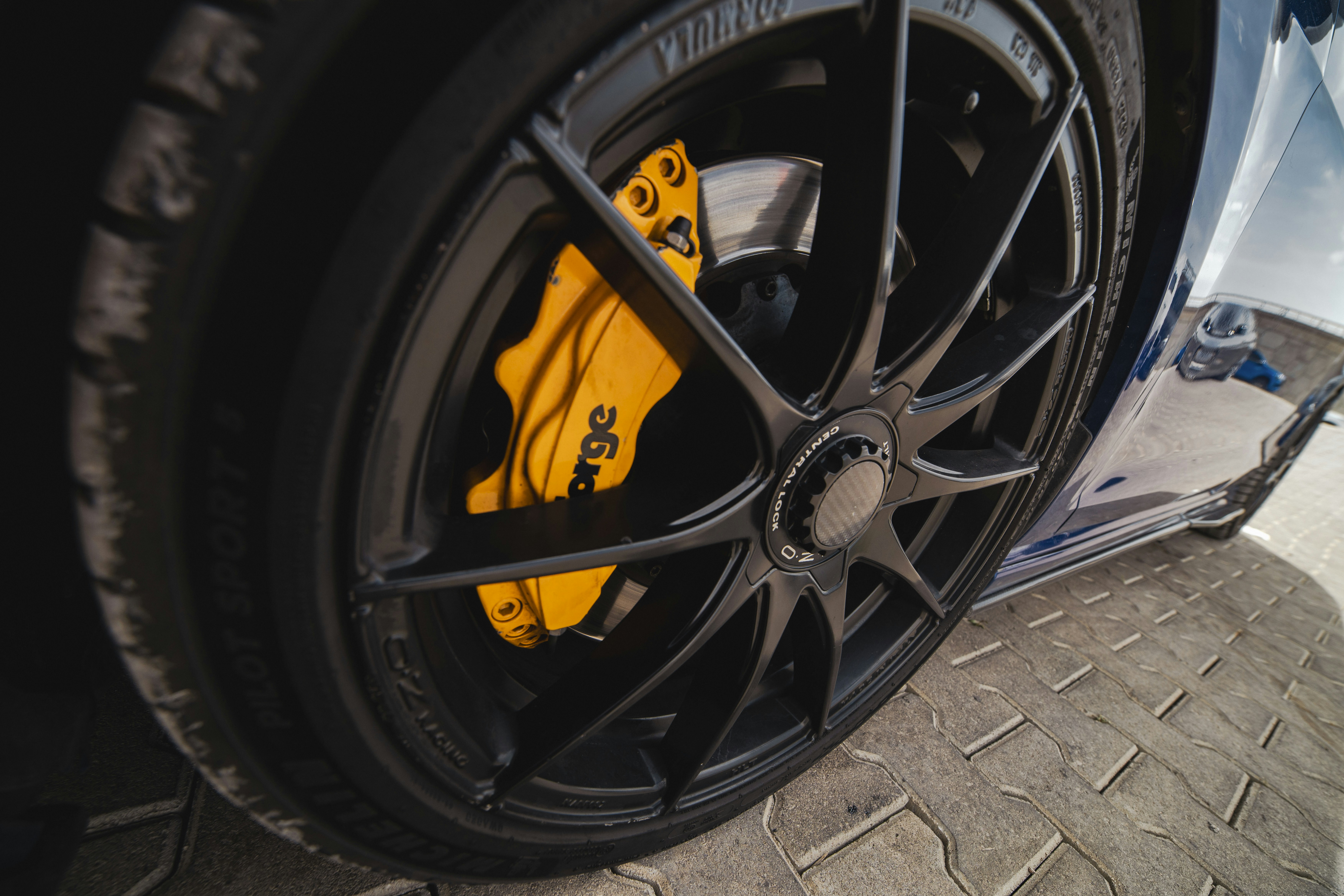 Black wheel with yellow brake caliper. photo – Free Wallpaper Image on ...