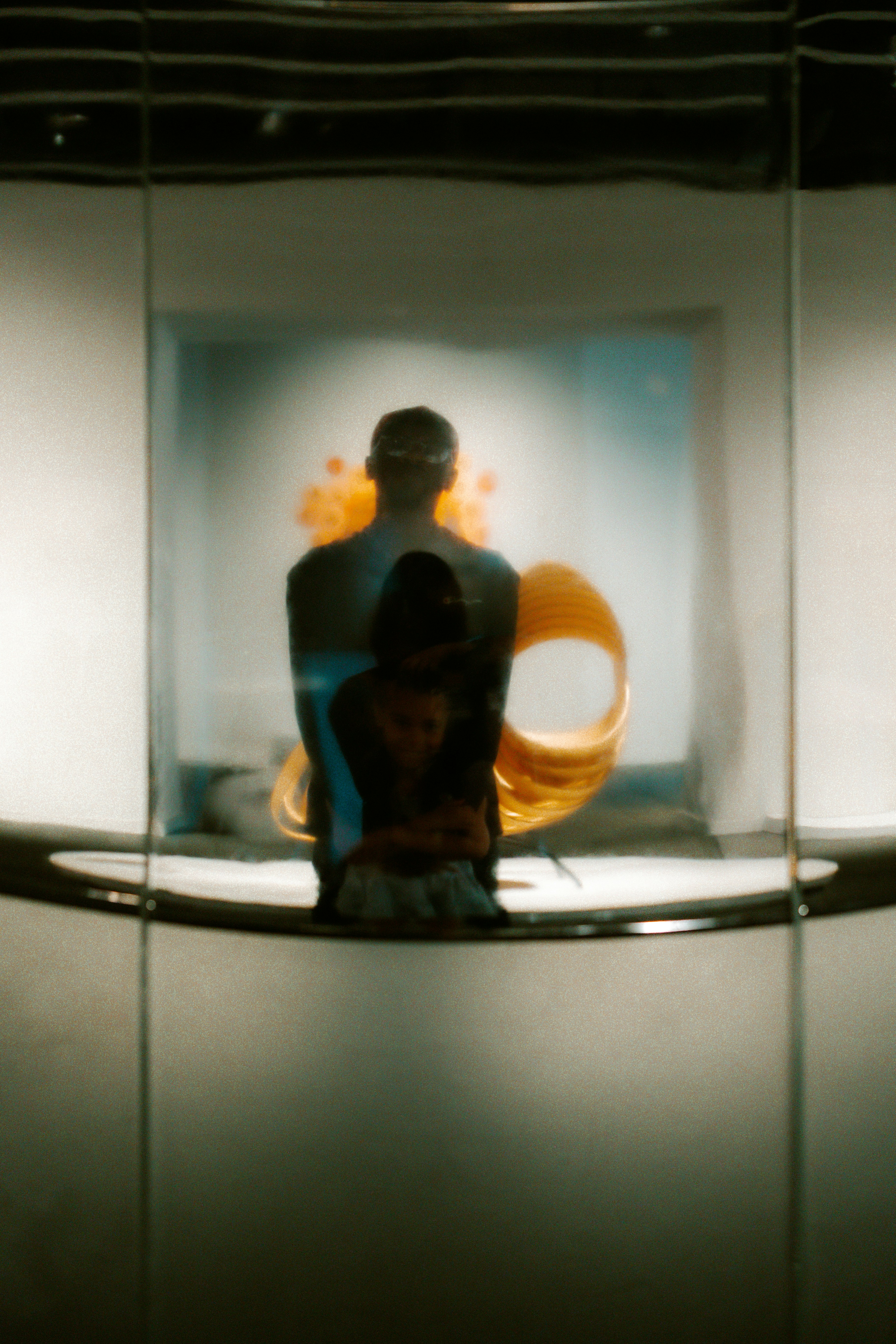 Silhouettes of people stand before an art piece. photo – Free Portrait ...