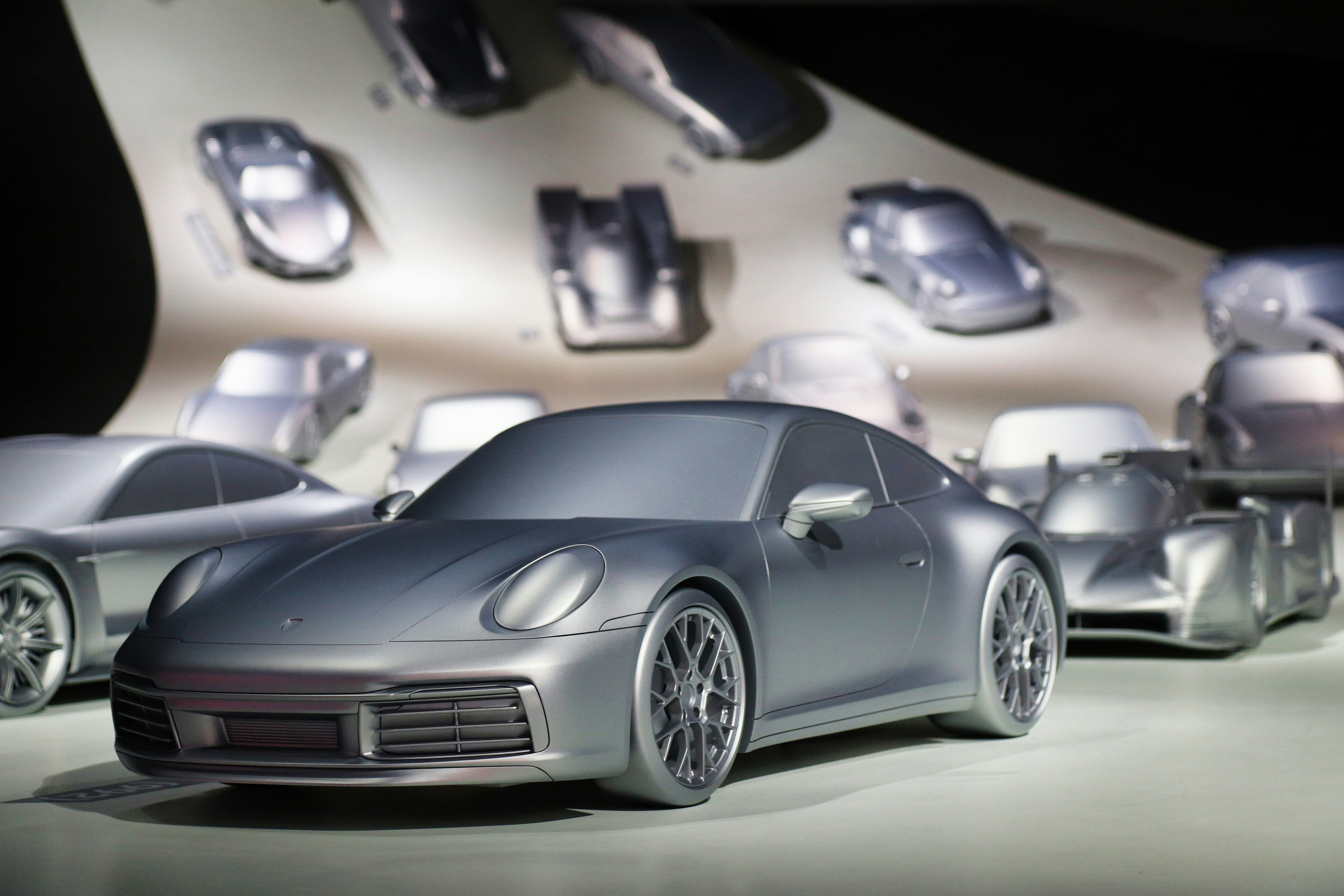 Porsche models are displayed in a showroom. photo – Free Sport Image on ...