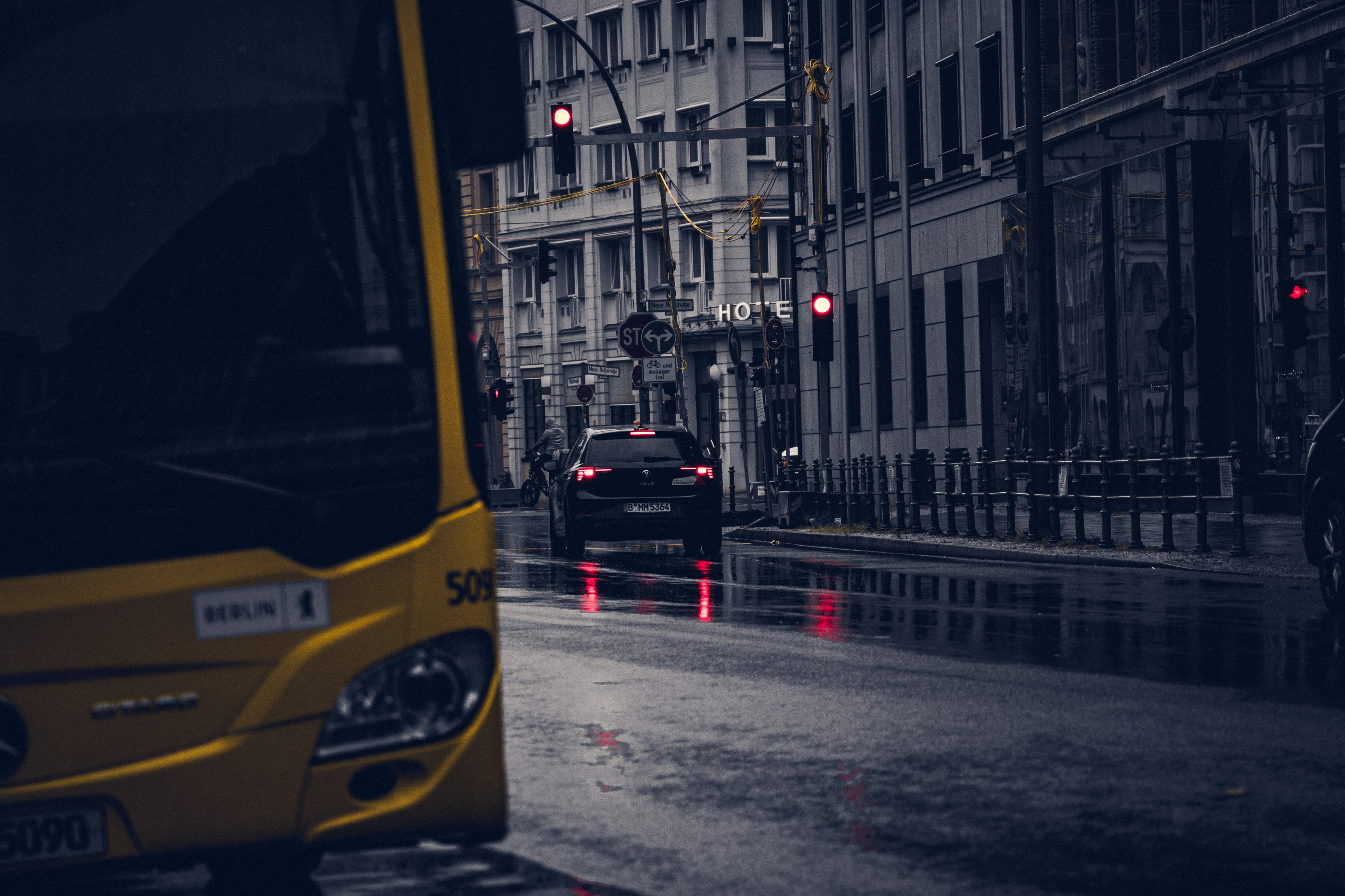 Rain-Soaked Crossroads: A Yellow Tram Leads Through Reflections