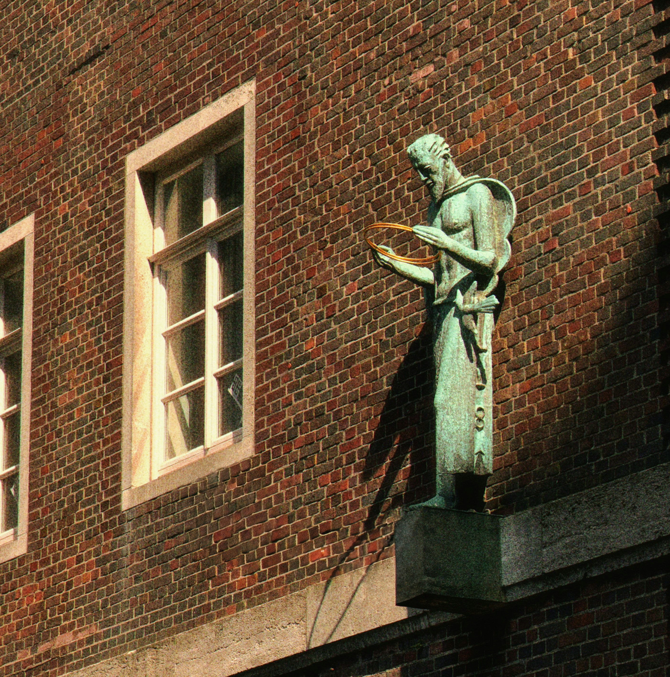 The Silent Observer: A Bronze Scholar on the Wall