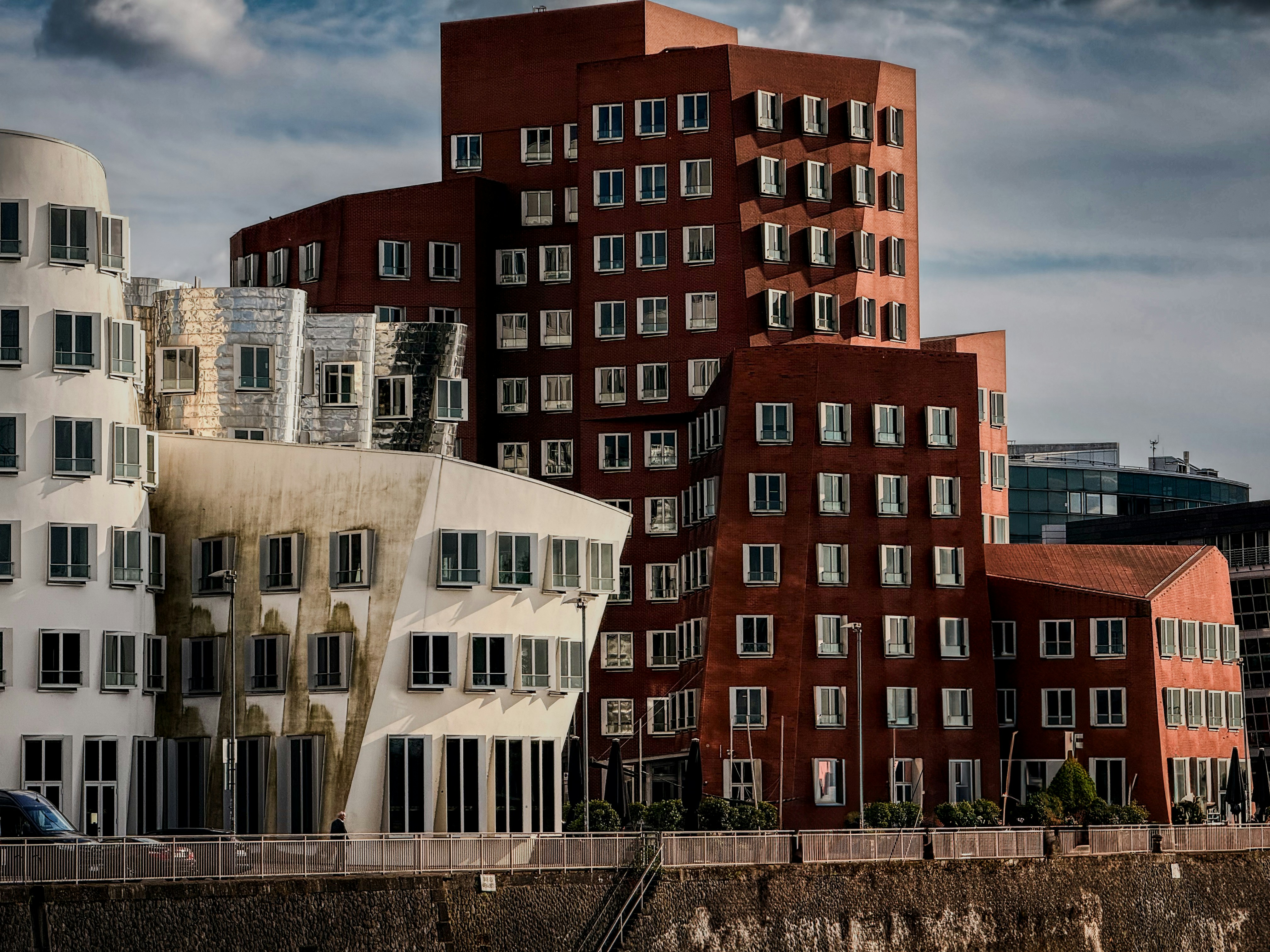 Modern, multi-colored buildings stand tall along the water. photo ...