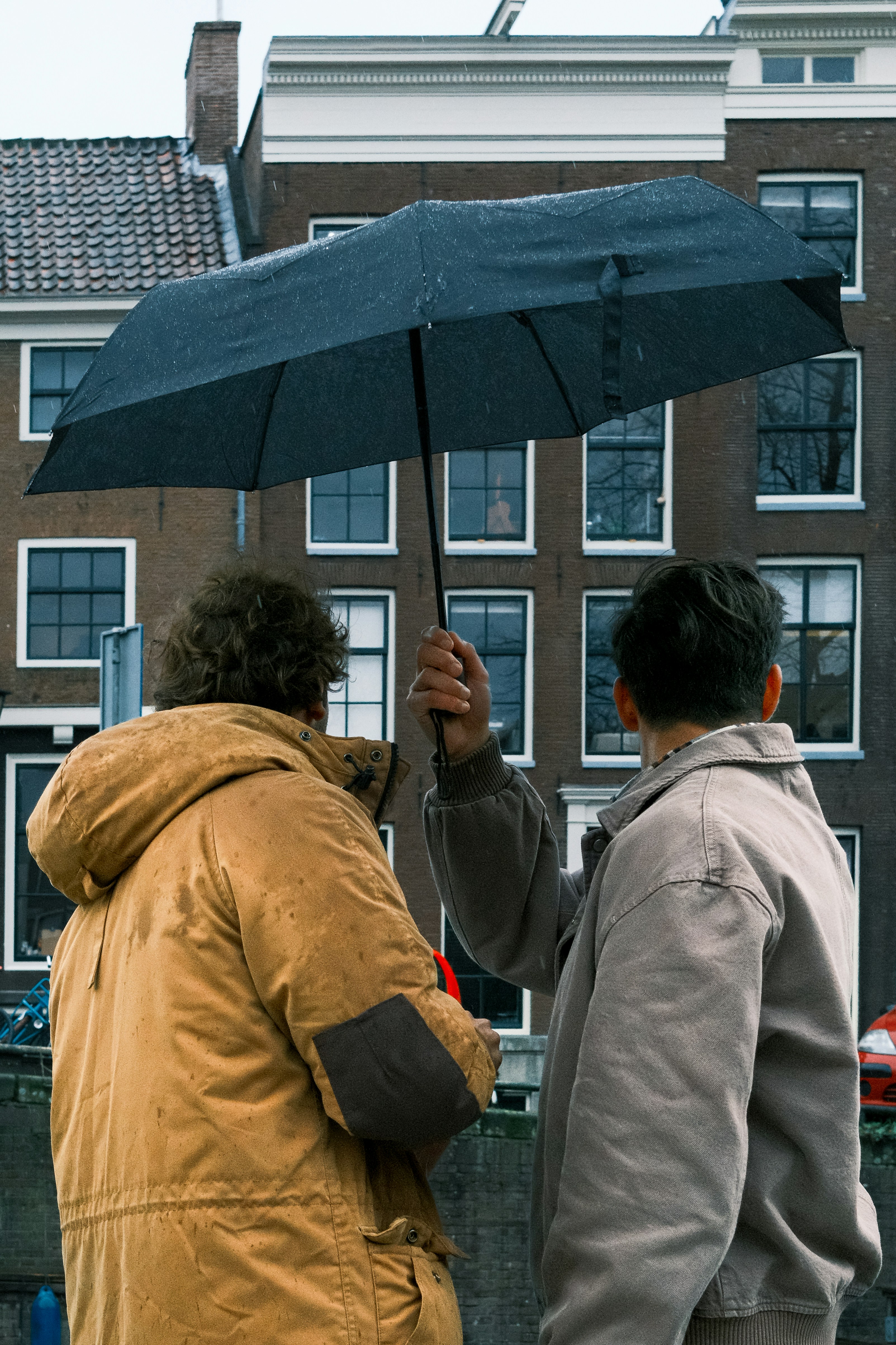 Two people are sharing an umbrella in the rain. photo – Free Rain Image ...