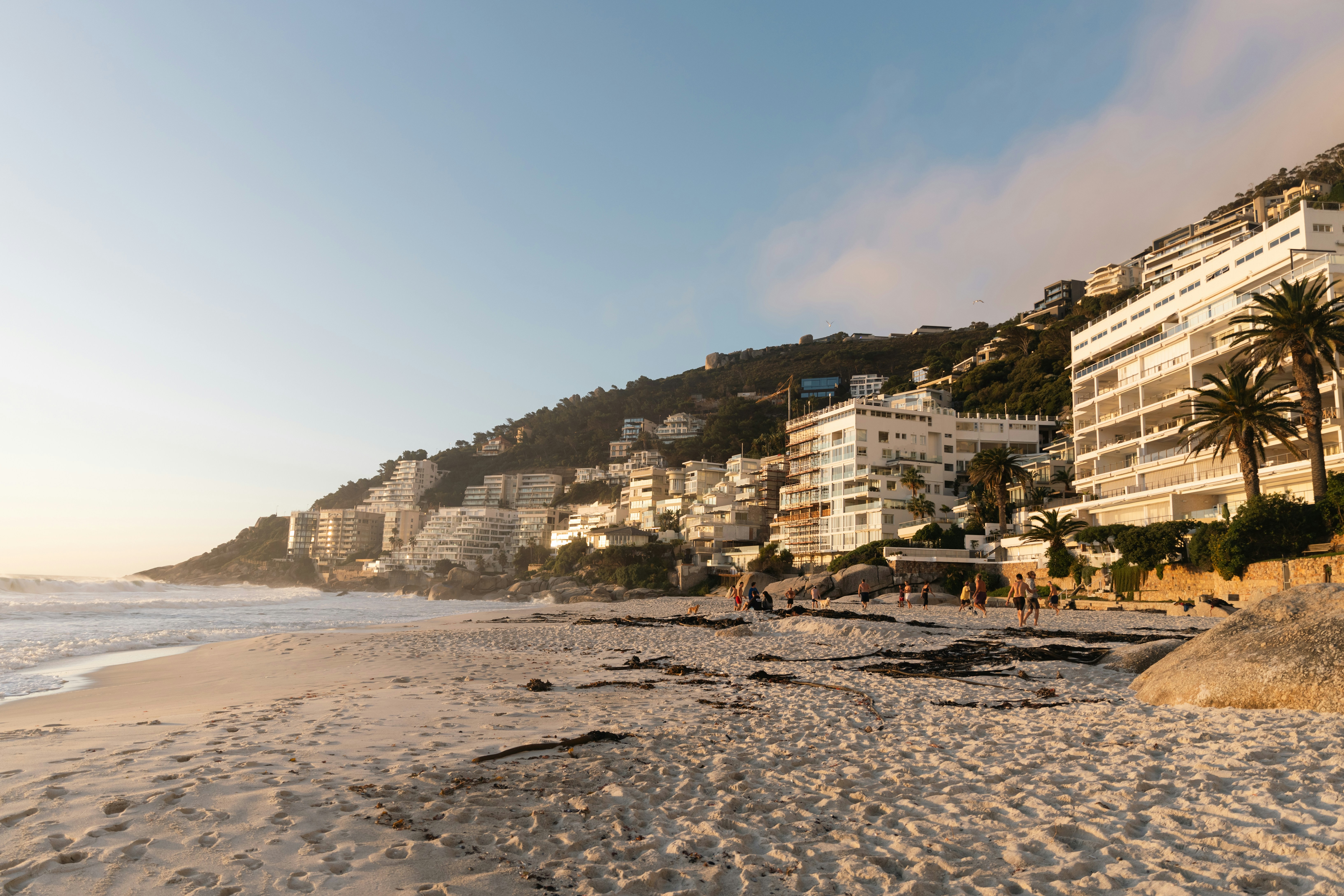 Scenic Clifton sunset scene. | Beachfront buildings line the coast at sunset.