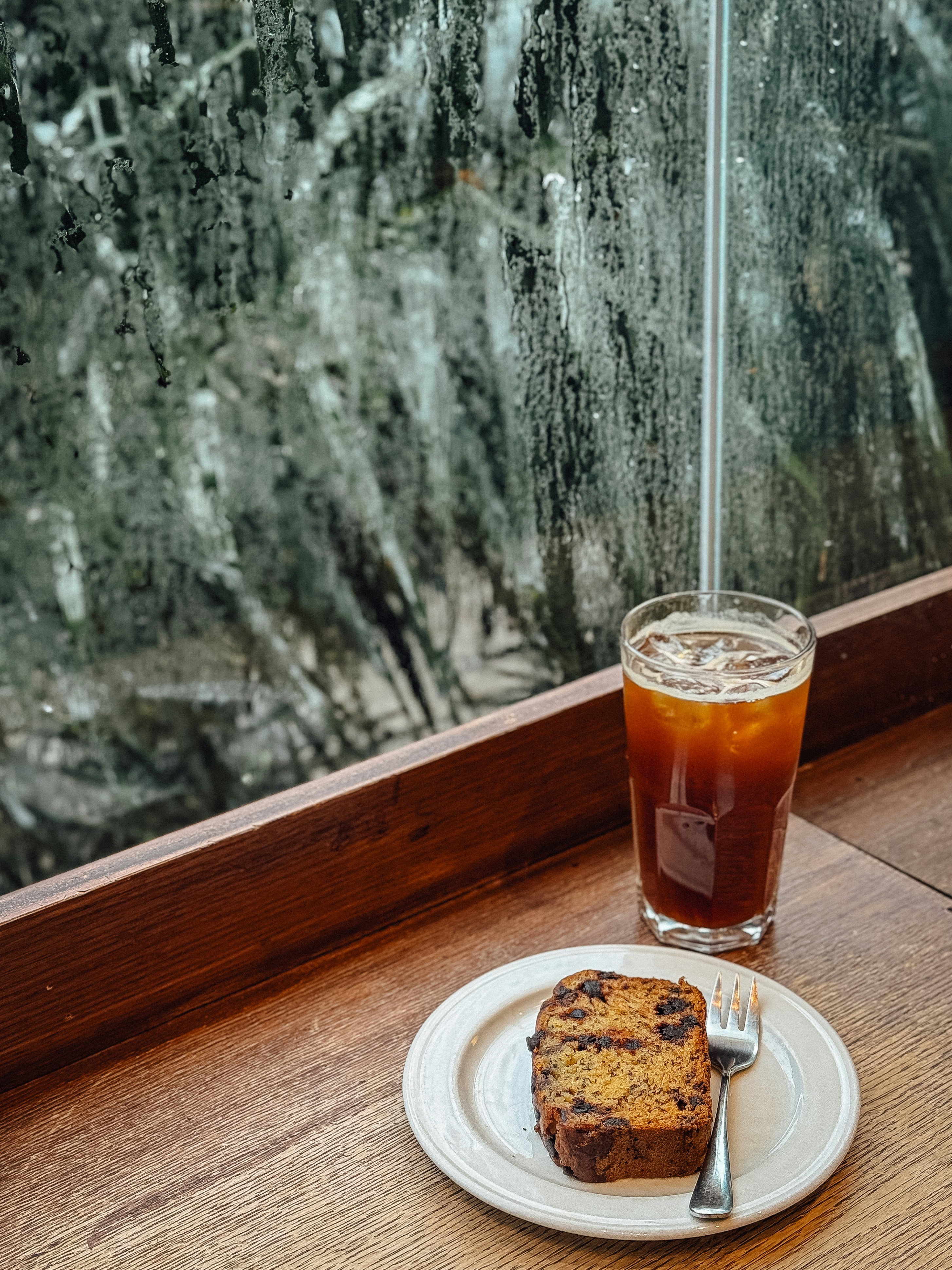 Banana bread by the rain-streaked window: a window-side bite