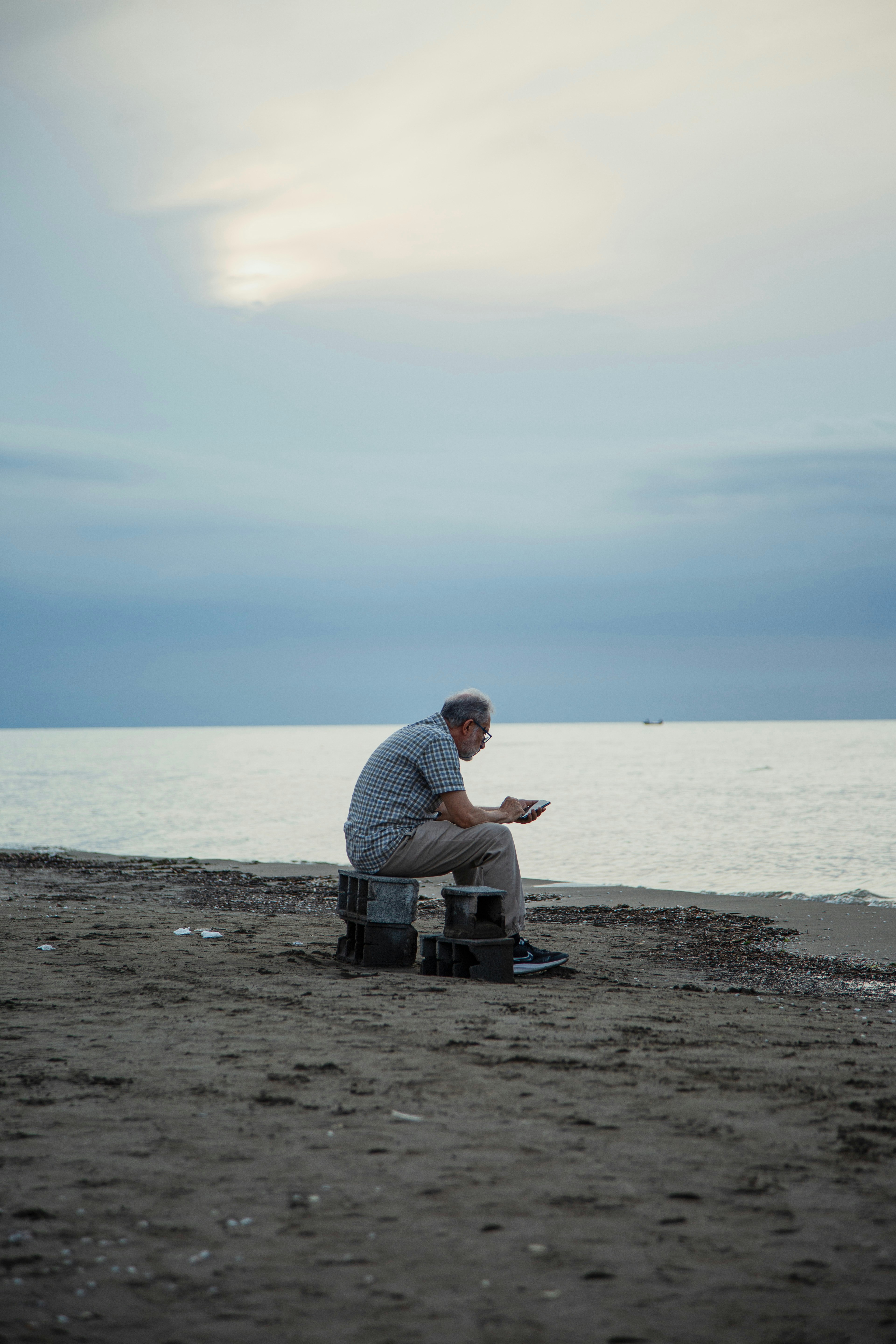 Solitary Moments: An Elder Gentleman Lost in Light by the Shore