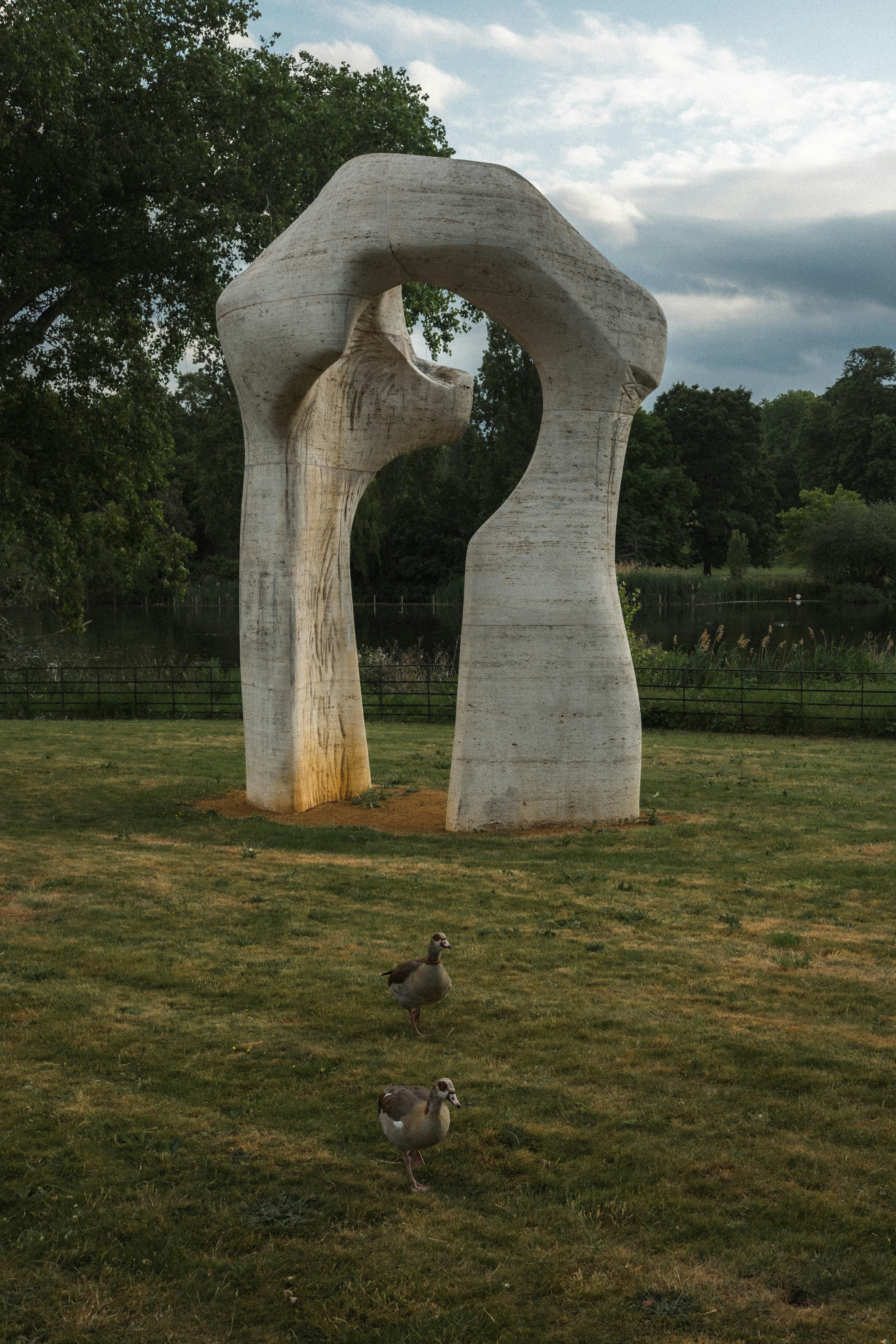 Echo Arch at Dusk: A Park Sculpture Framed by Ducks