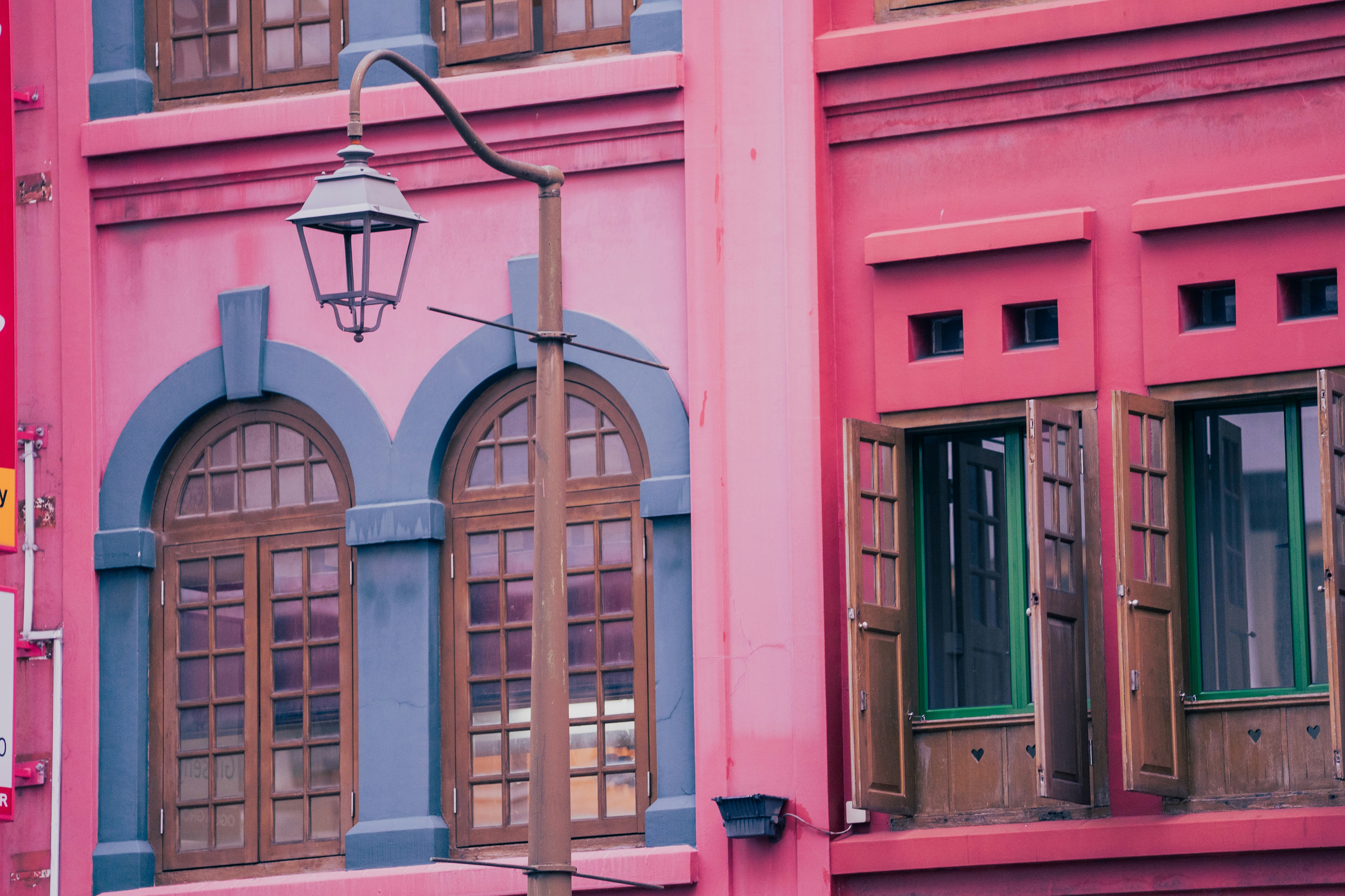 Arched Indigo Windows on a Bubblegum Pink Facade