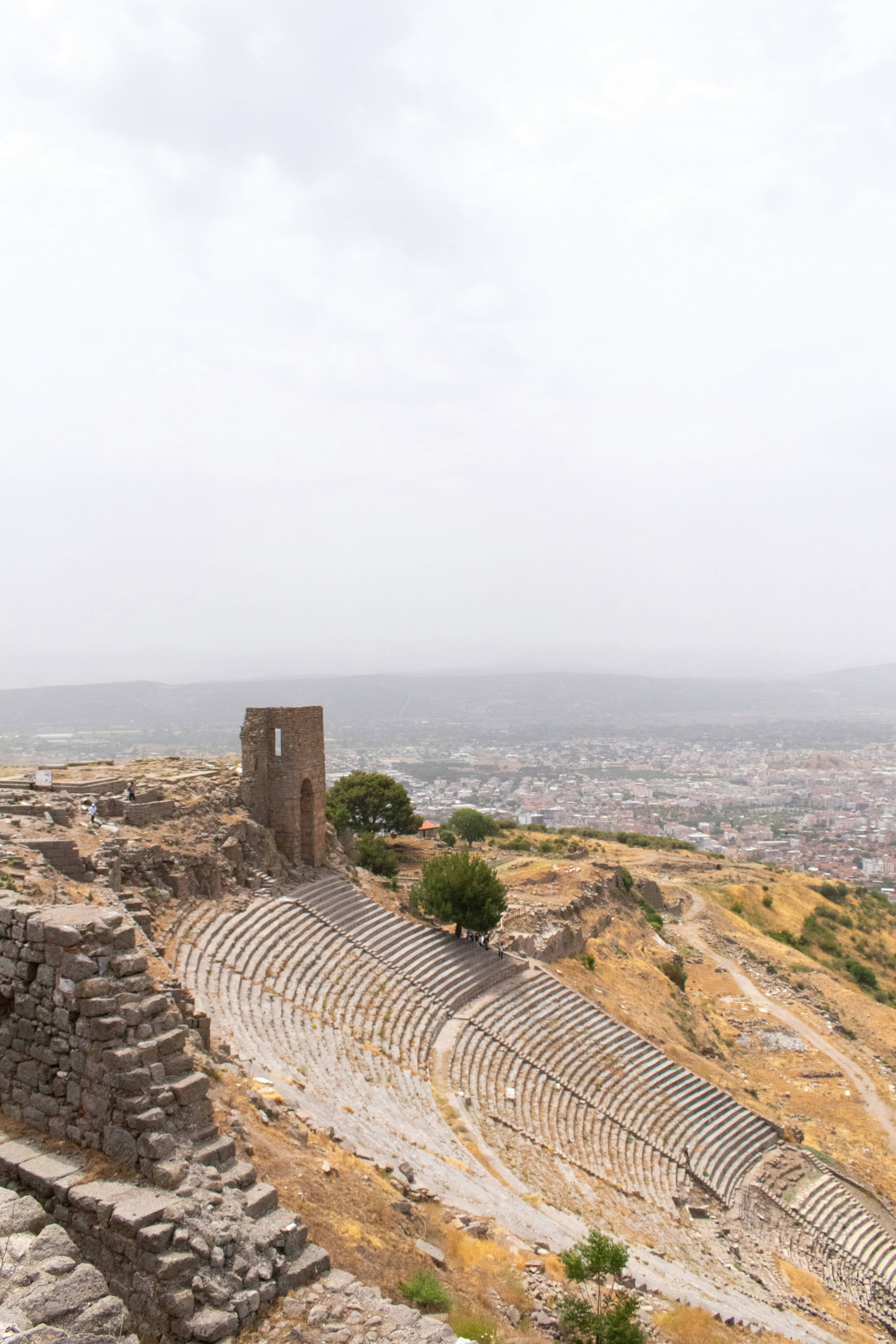 Stones That Echo a City: Ancient Amphitheater perches above a distant horizon