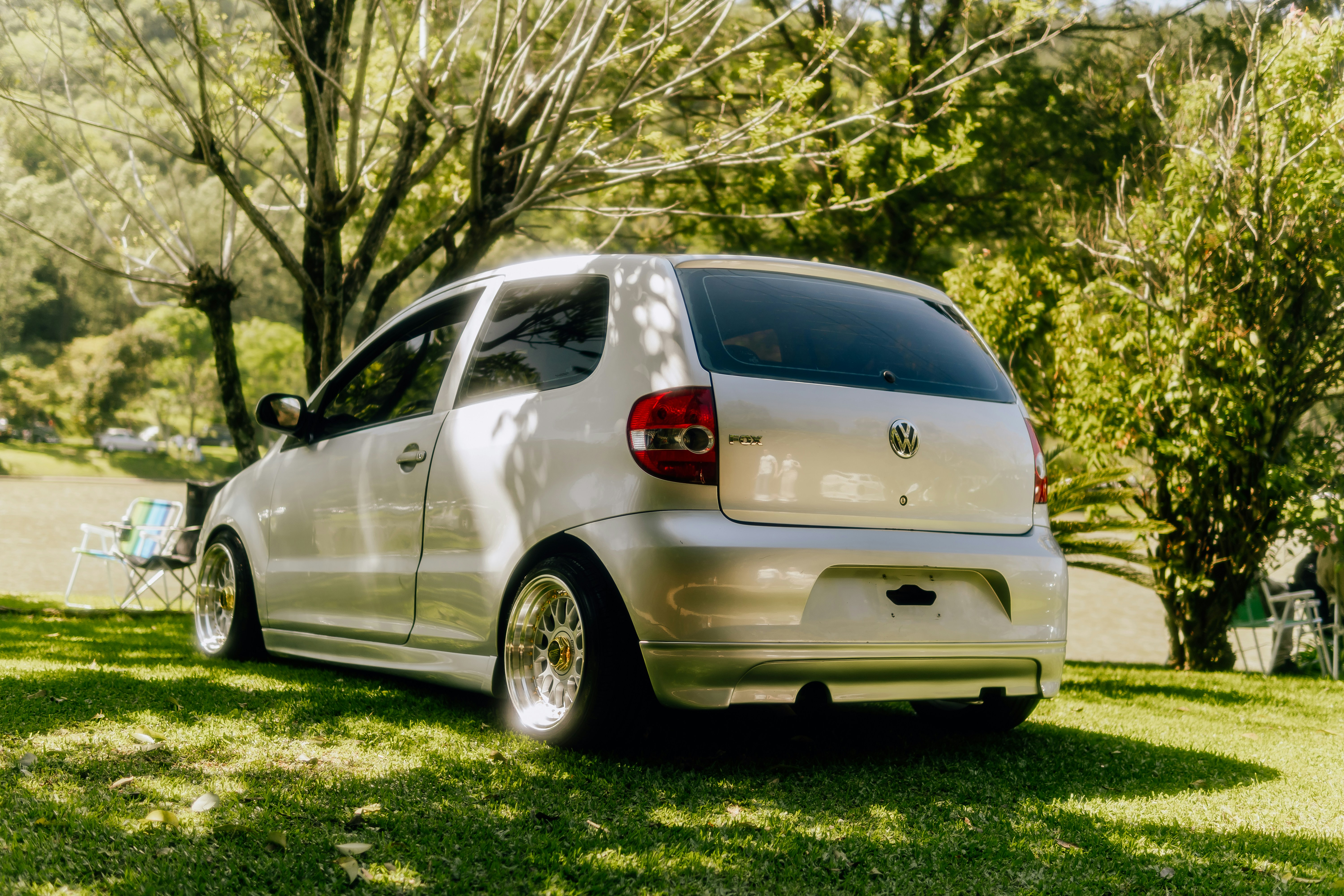 Silver VW Shifts Quietly into a Shaded Park Clearing