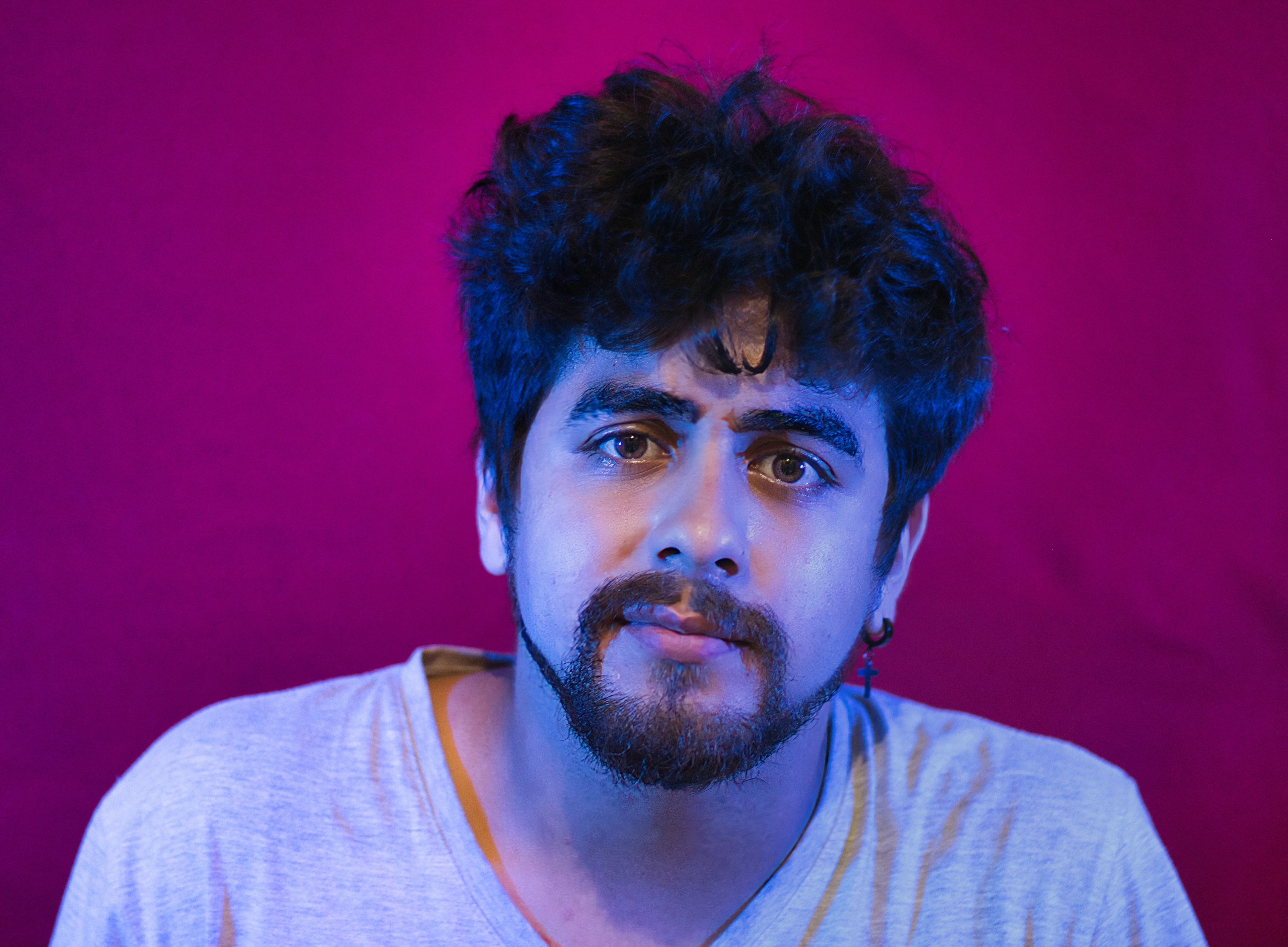 Portrait in Neon Haze: A Composed Gaze Under Magenta-Blue Light