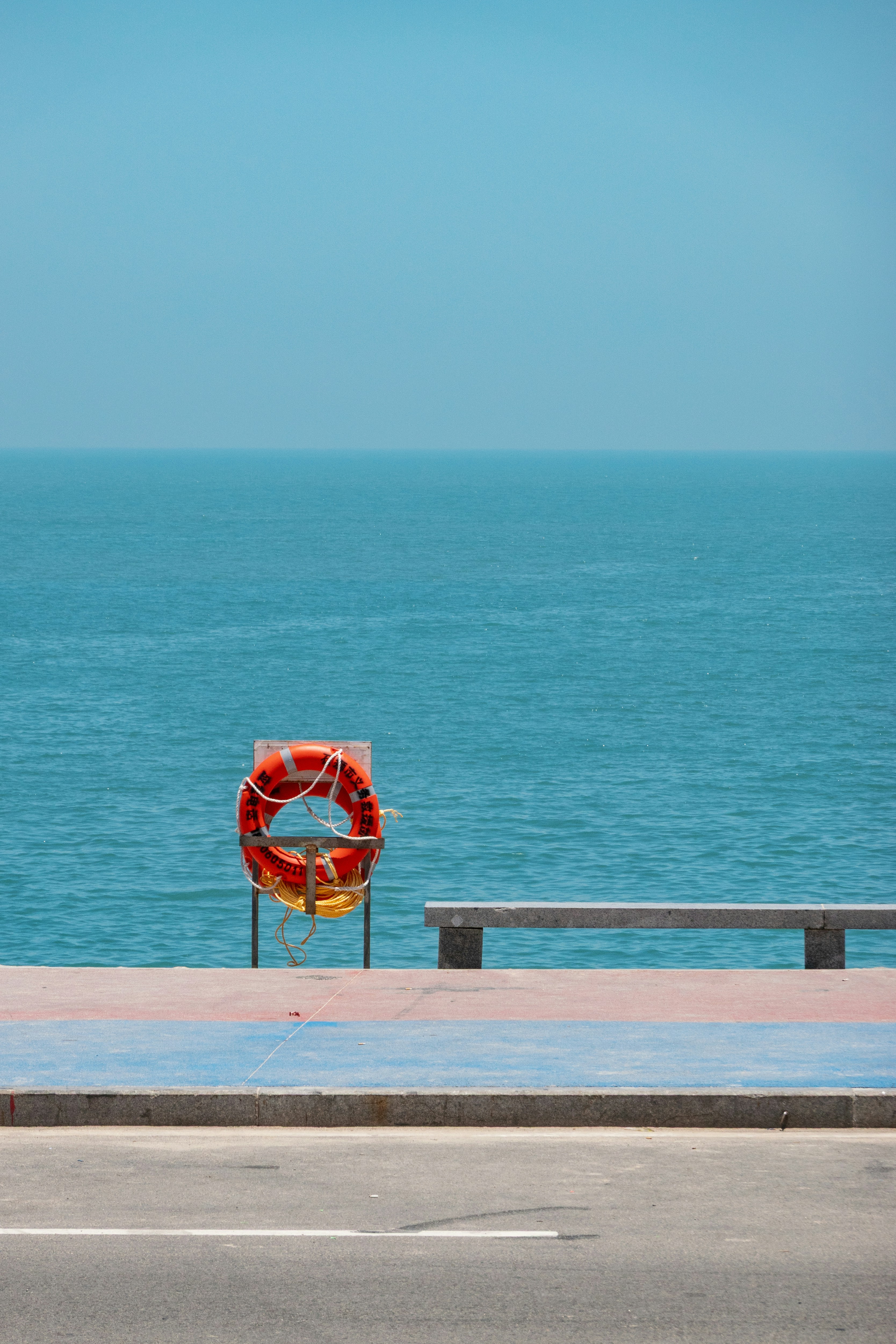 Lifebuoy at the Quiet Edge of the Sea
