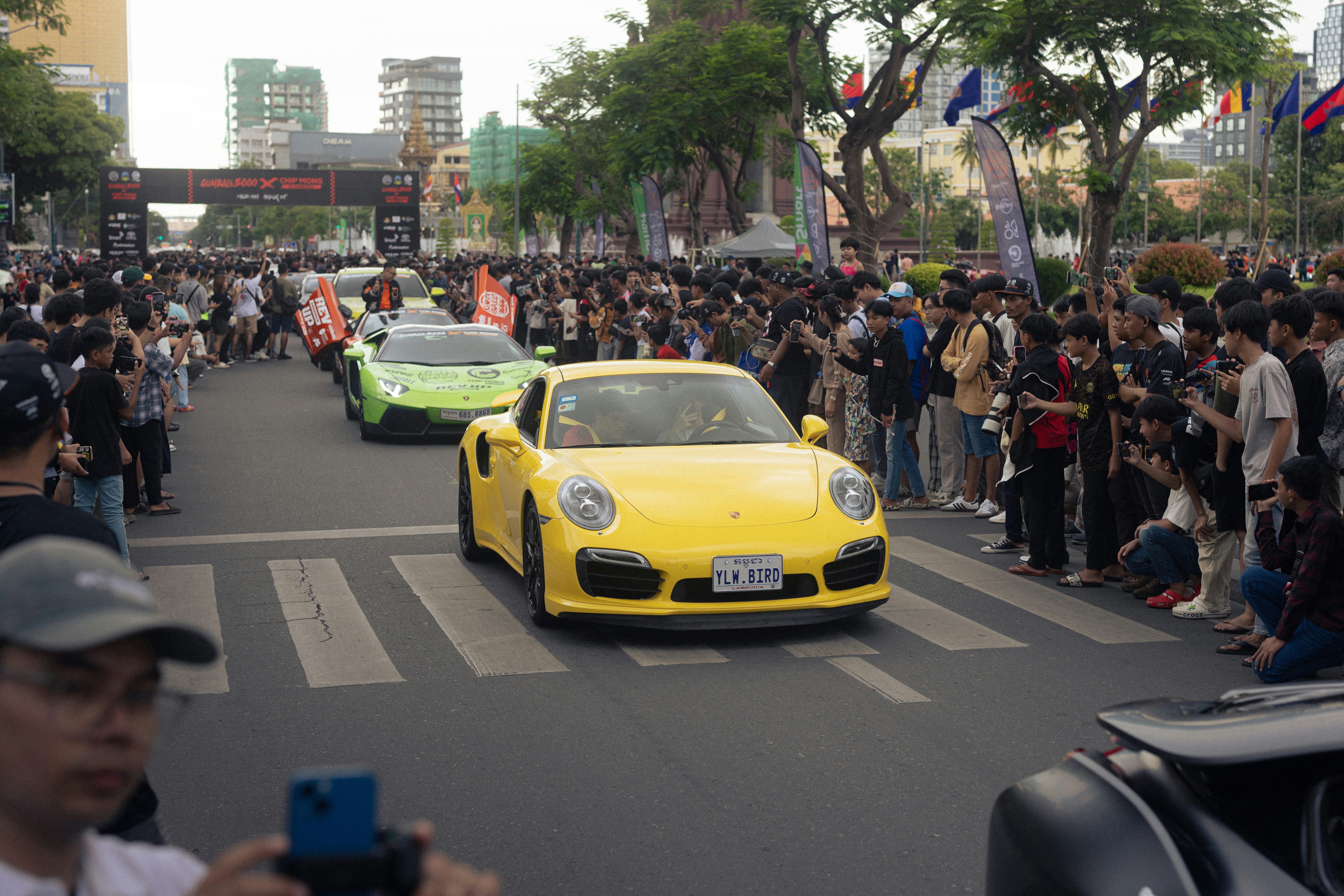 Yellow porsche leads a street parade of cars. photo – Free Bmw Image on ...