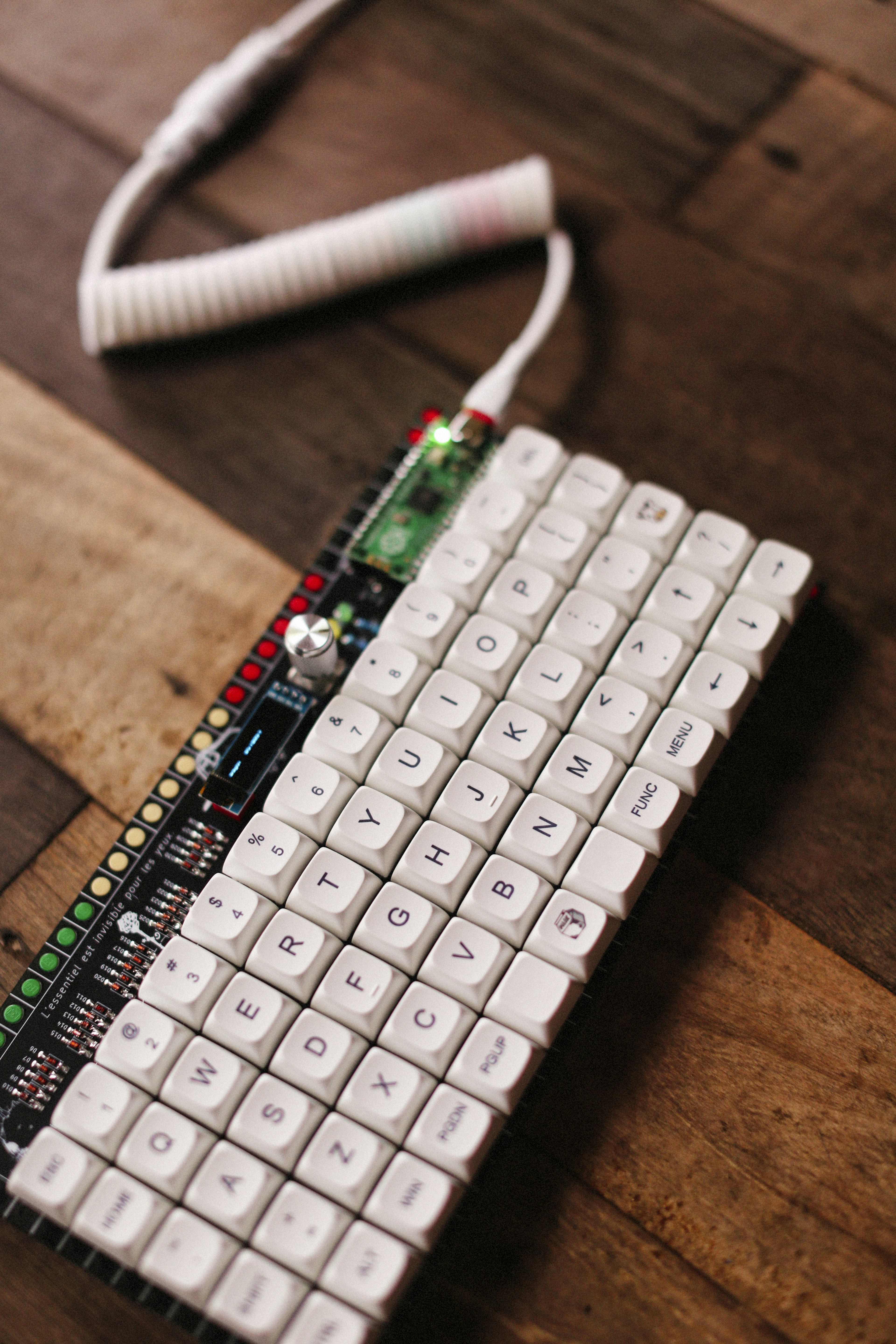 A homemade keyboard is pictured on a wooden surface. photo – Free ...