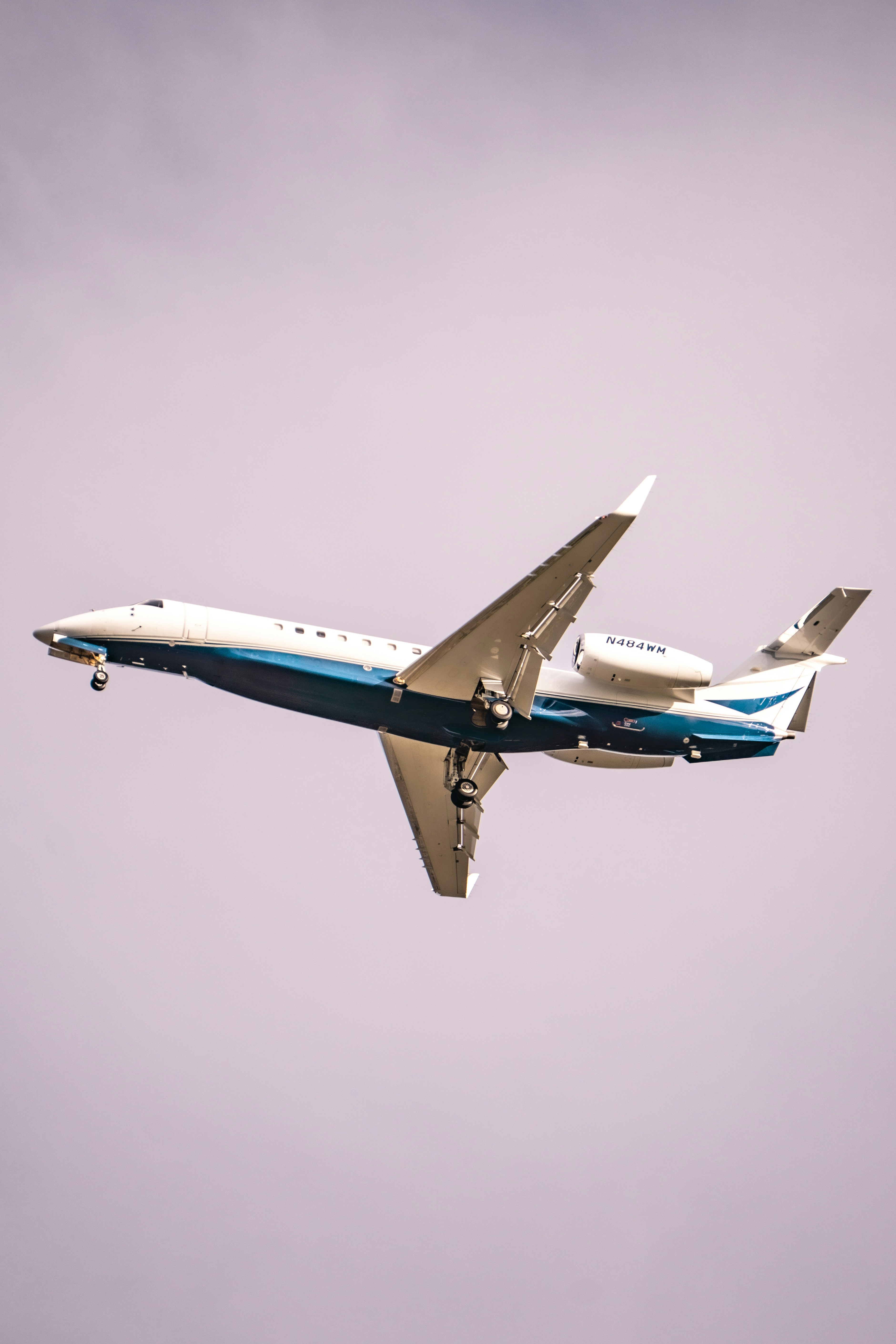 Jet in ascent: mid-flight symmetry against a pastel sky