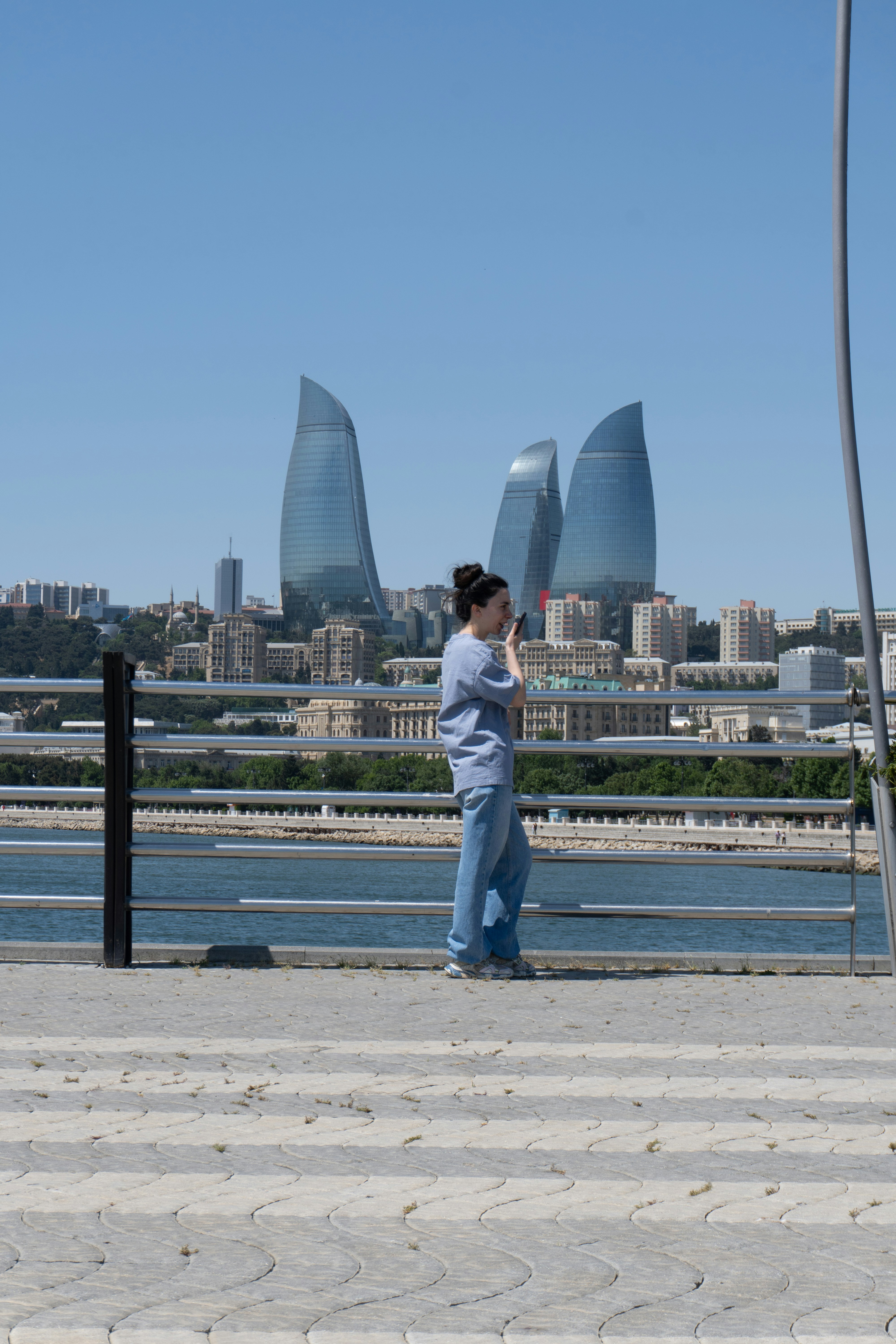 Portrait by the Waterfront: Baku's Flame Towers Framing a Quiet Moment