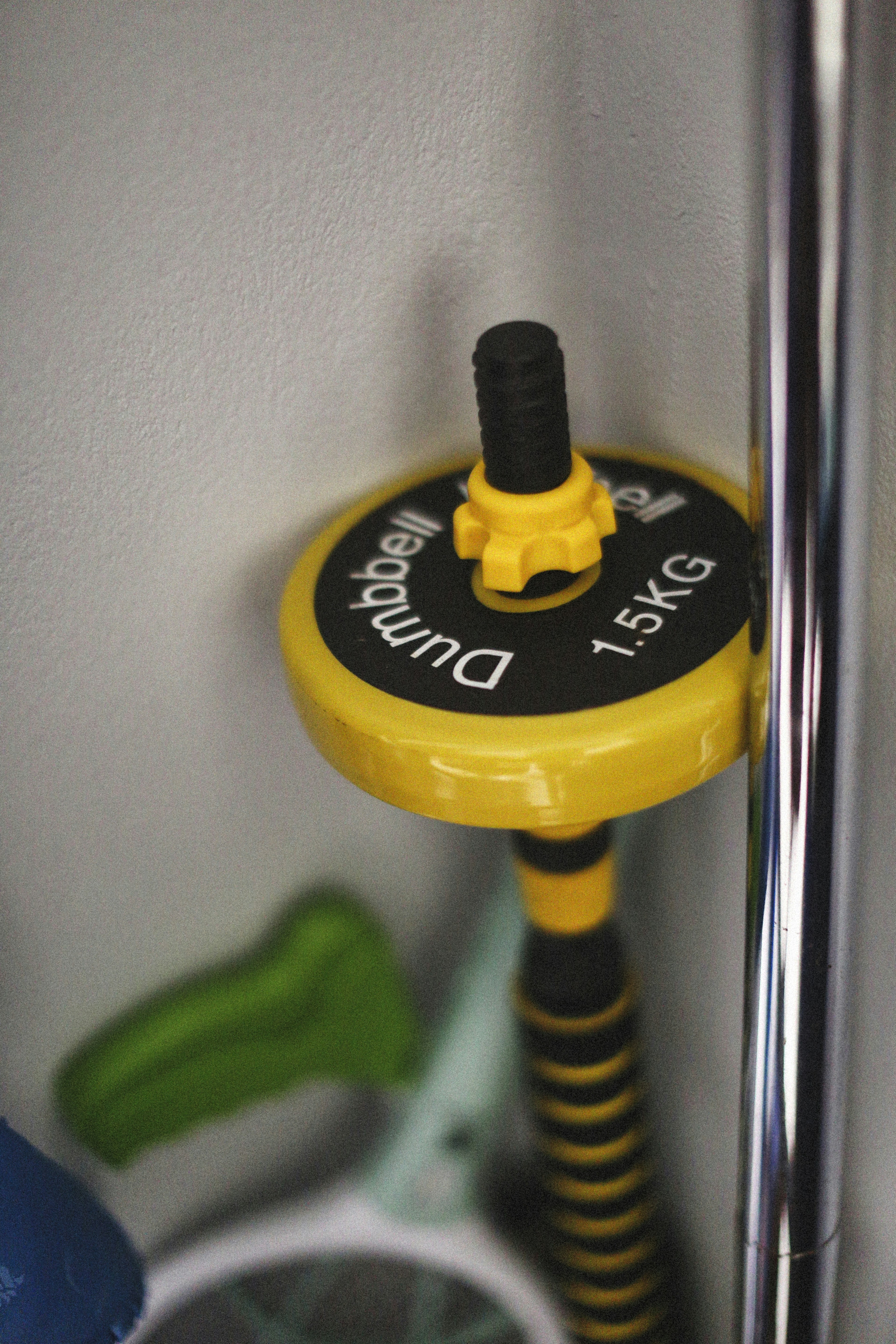 Yellow valve cap with black knob in a utilitarian cabinet