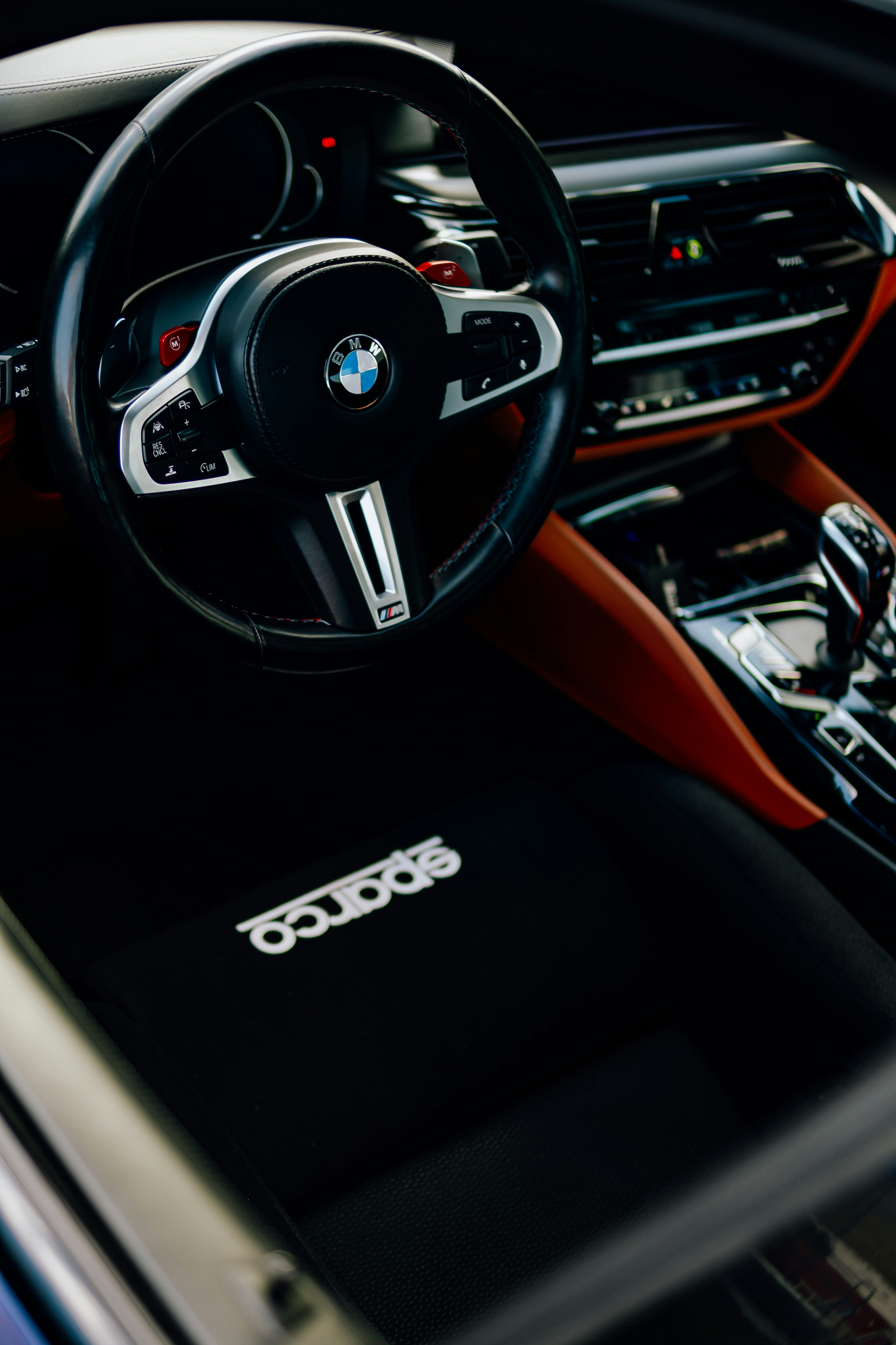 BMW cockpit in focus: steering wheel and red leather center console