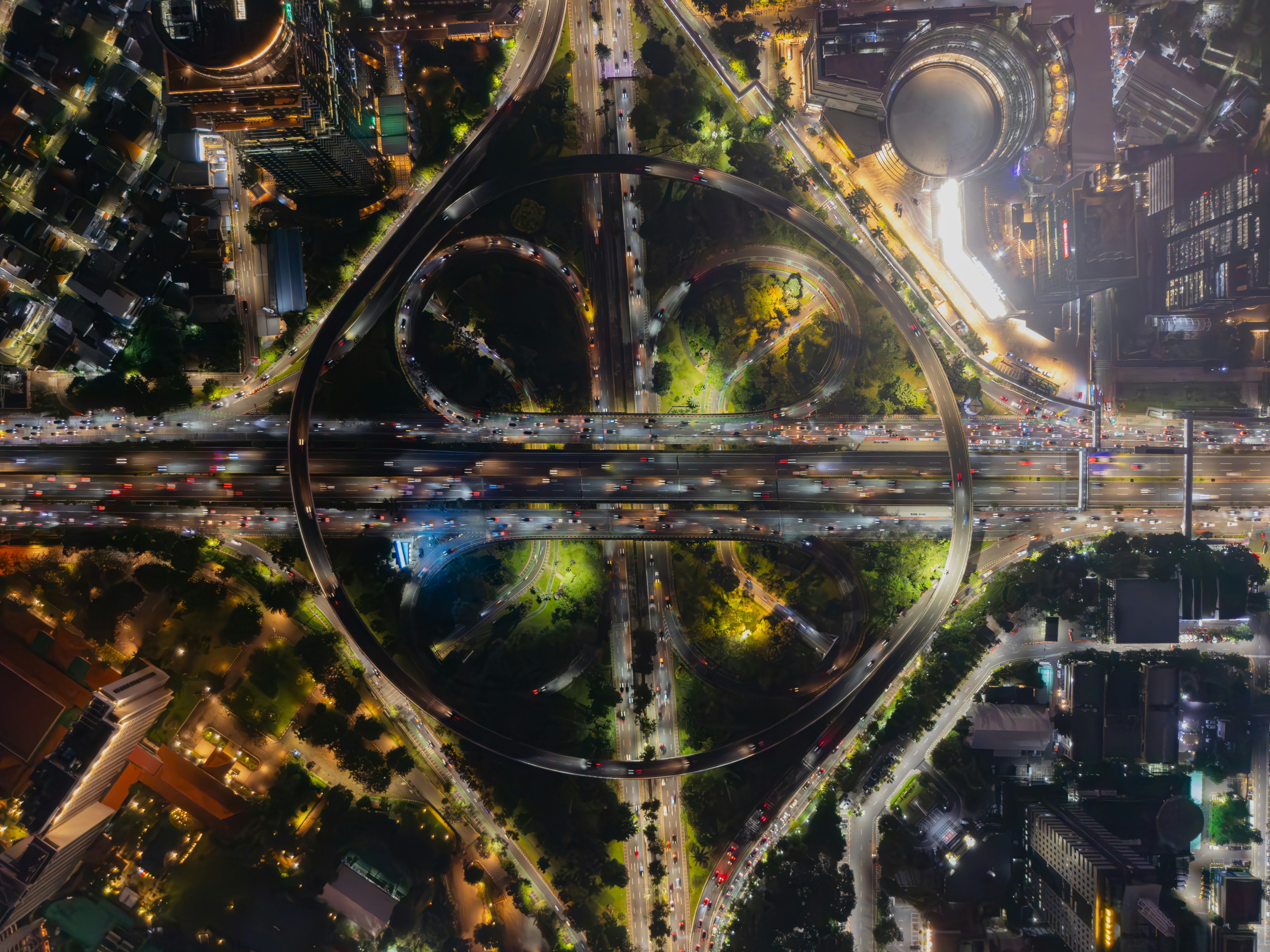 Simpang Susun Semanggi | Nighttime overhead view of a city's intricate highway.
