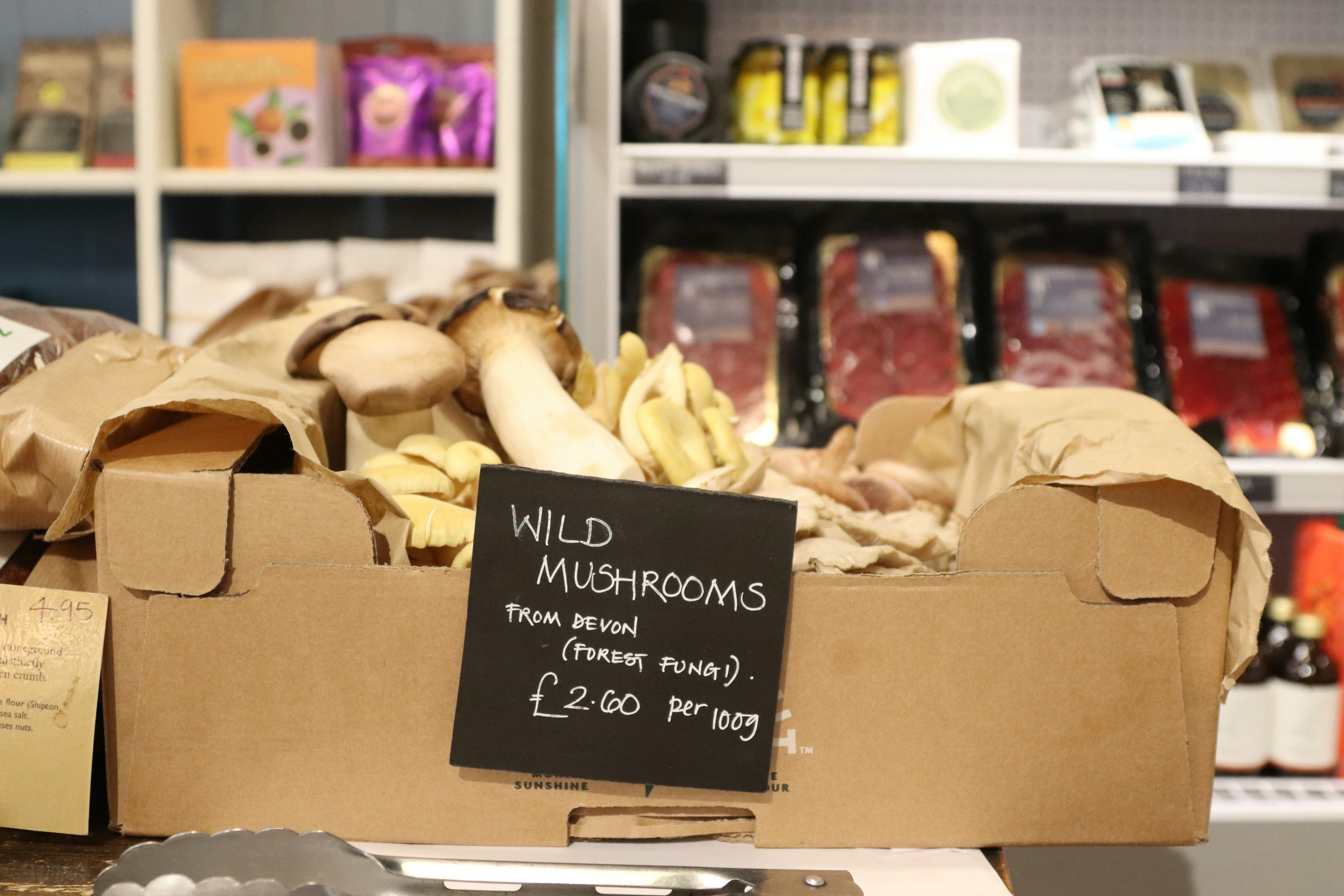 Chalkboard Sign Anchors Fresh Wild Mushrooms in a Market Display