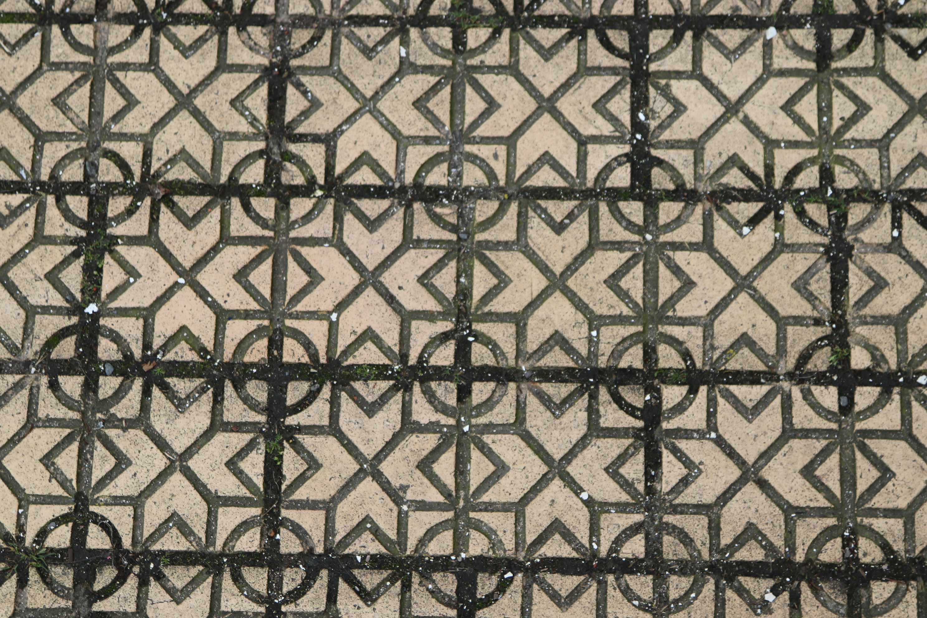 Geometric tile design on a ground surface.