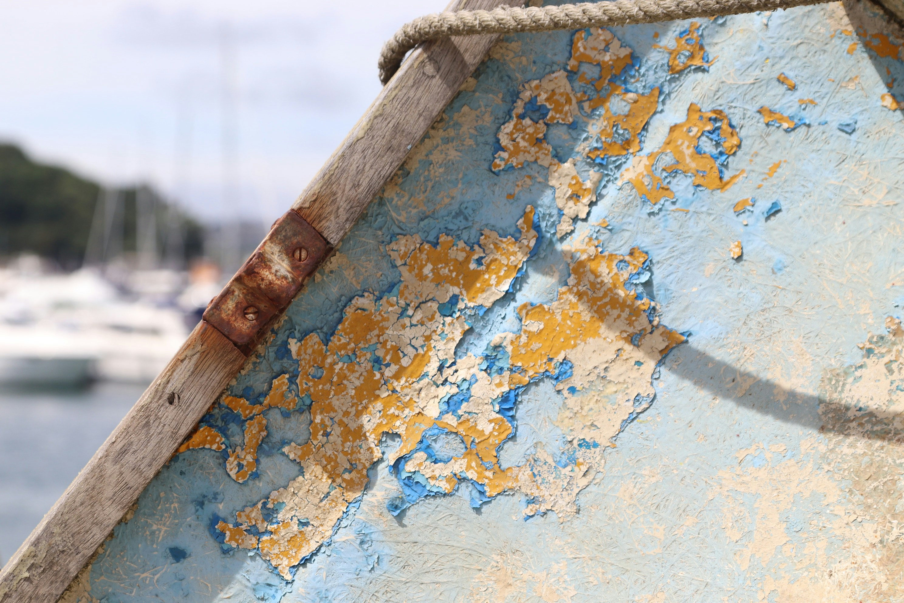 Patina in Weather: Close-Up of a Chipped Blue Hull with Amber Patches