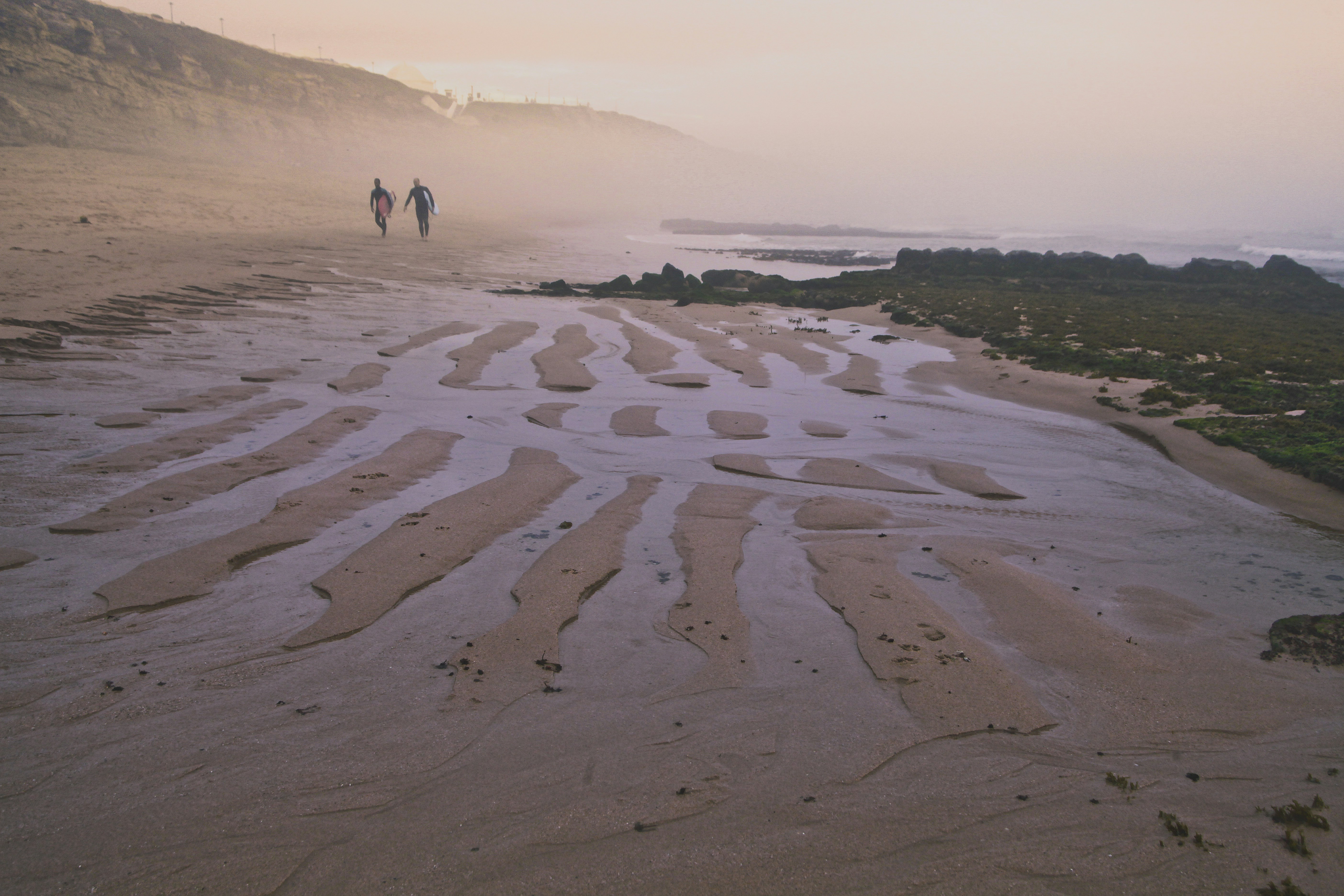 Ridge-Marked Shoreline: Two Silhouettes Thread Through Dawn Mist