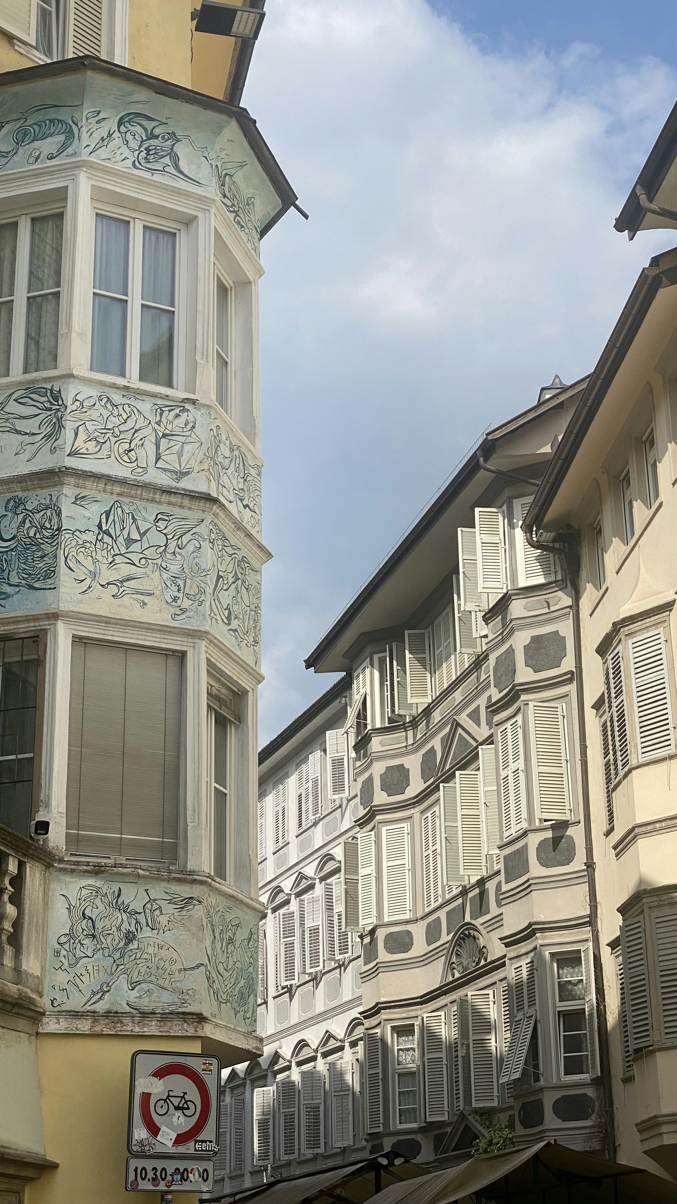 Intricately designed buildings with decorative facades framing a quaint street corner, showcasing the charm of historic architecture.