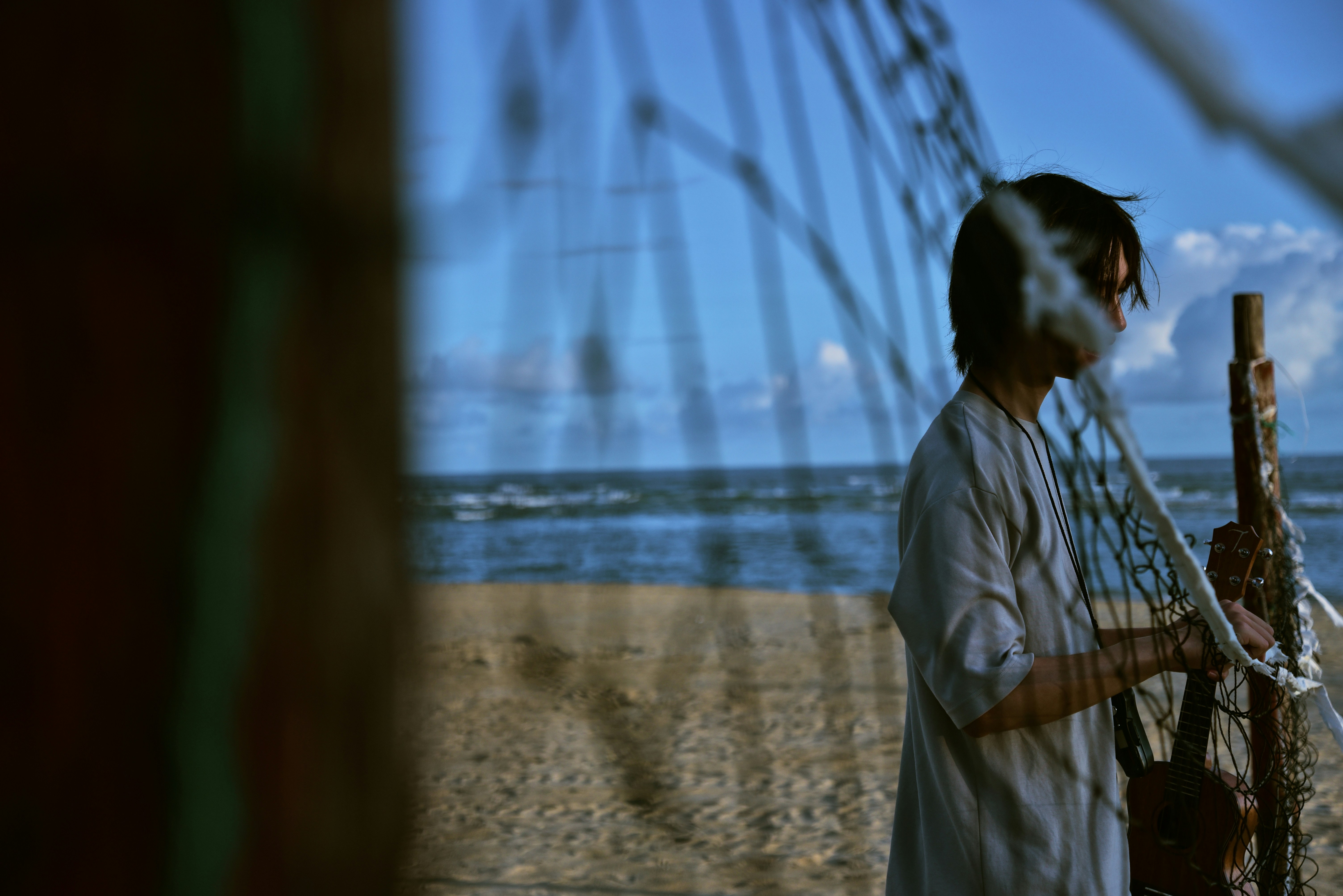 A person looks out at the ocean from a ship.