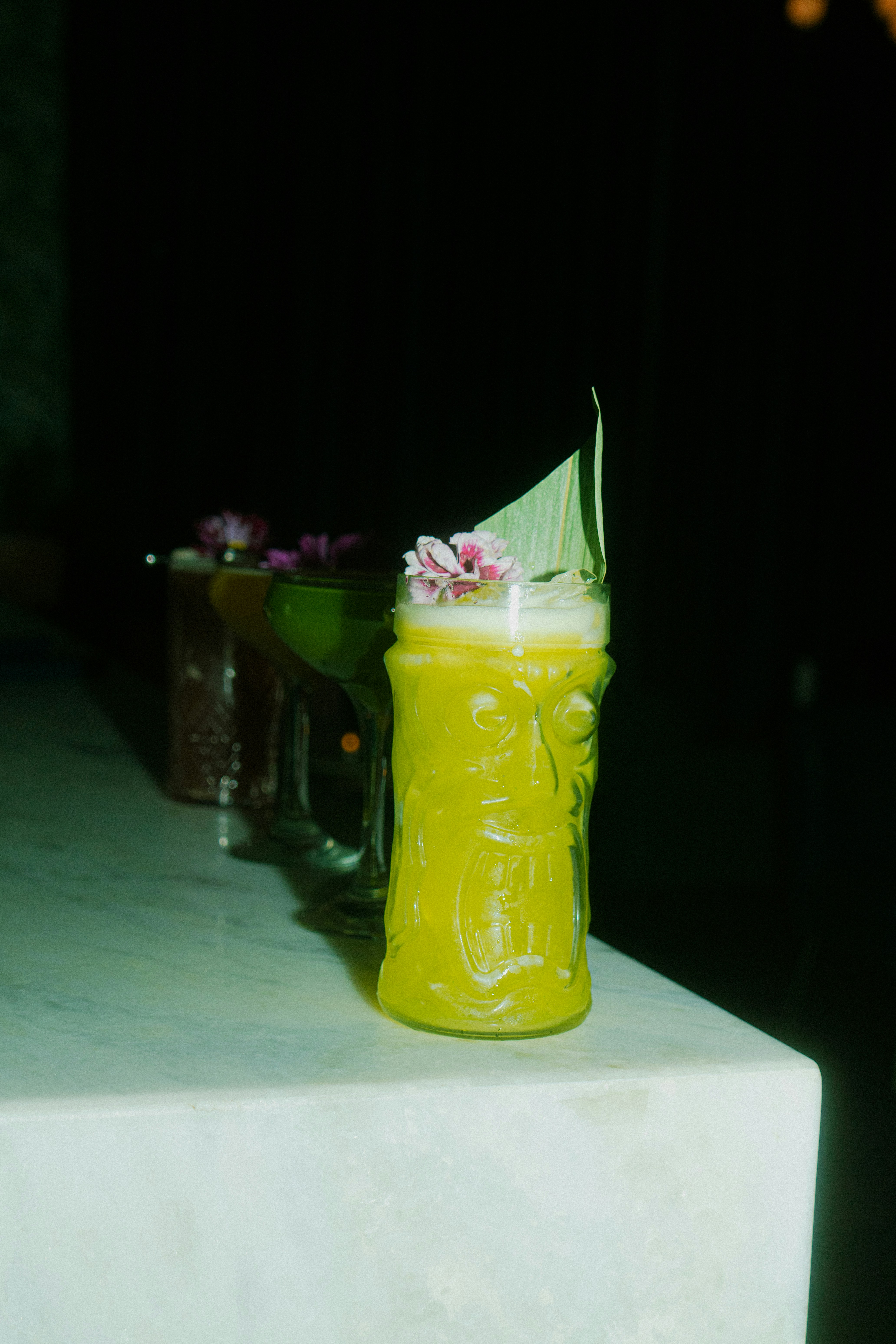 Moonlit Tropics: The Yellow Tiki on a Marble Bar