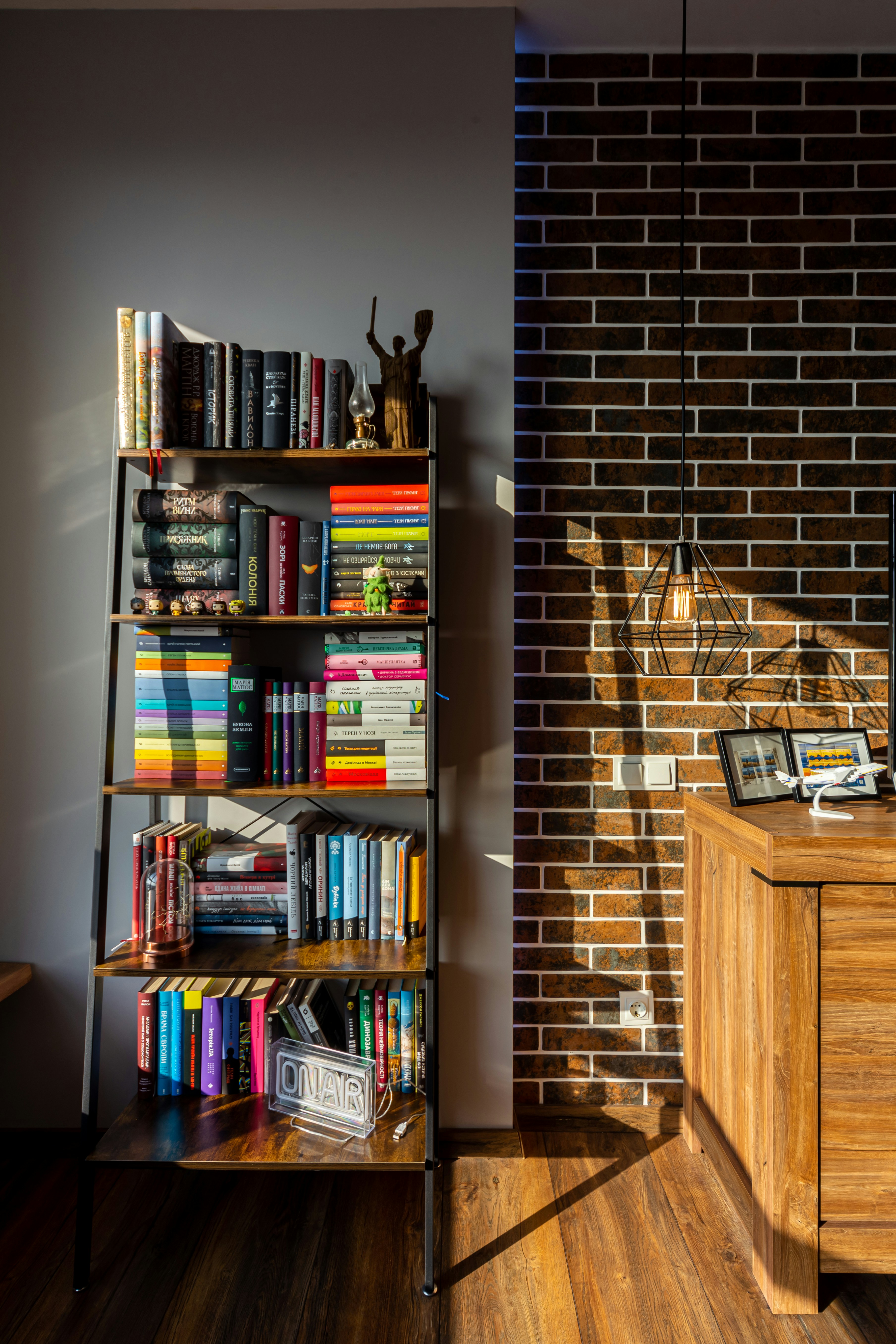Shelves of Stories: A Cozy Study Corner with Brick Wall and Warm Light