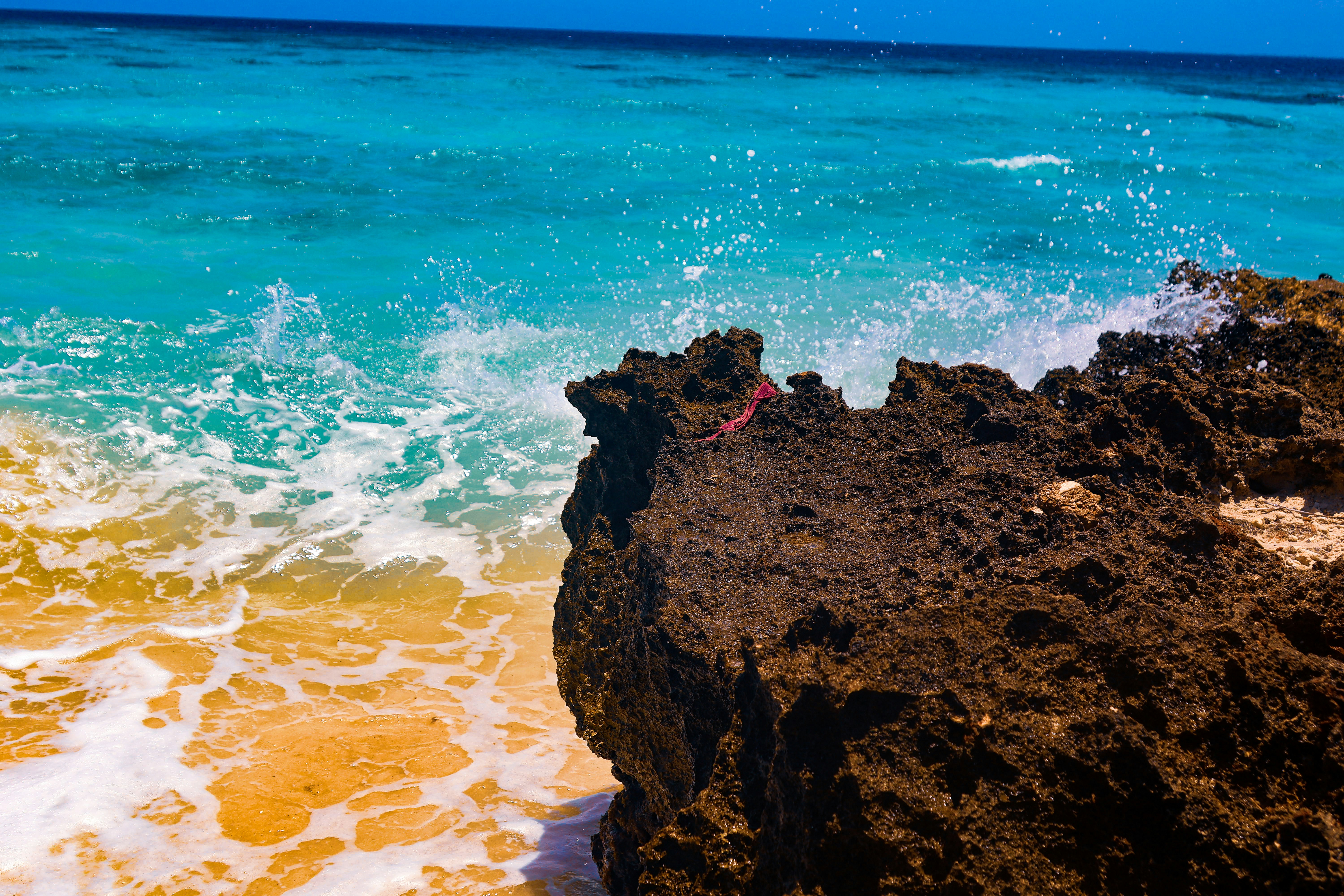 The Dance of Waves Against Ancient Rock