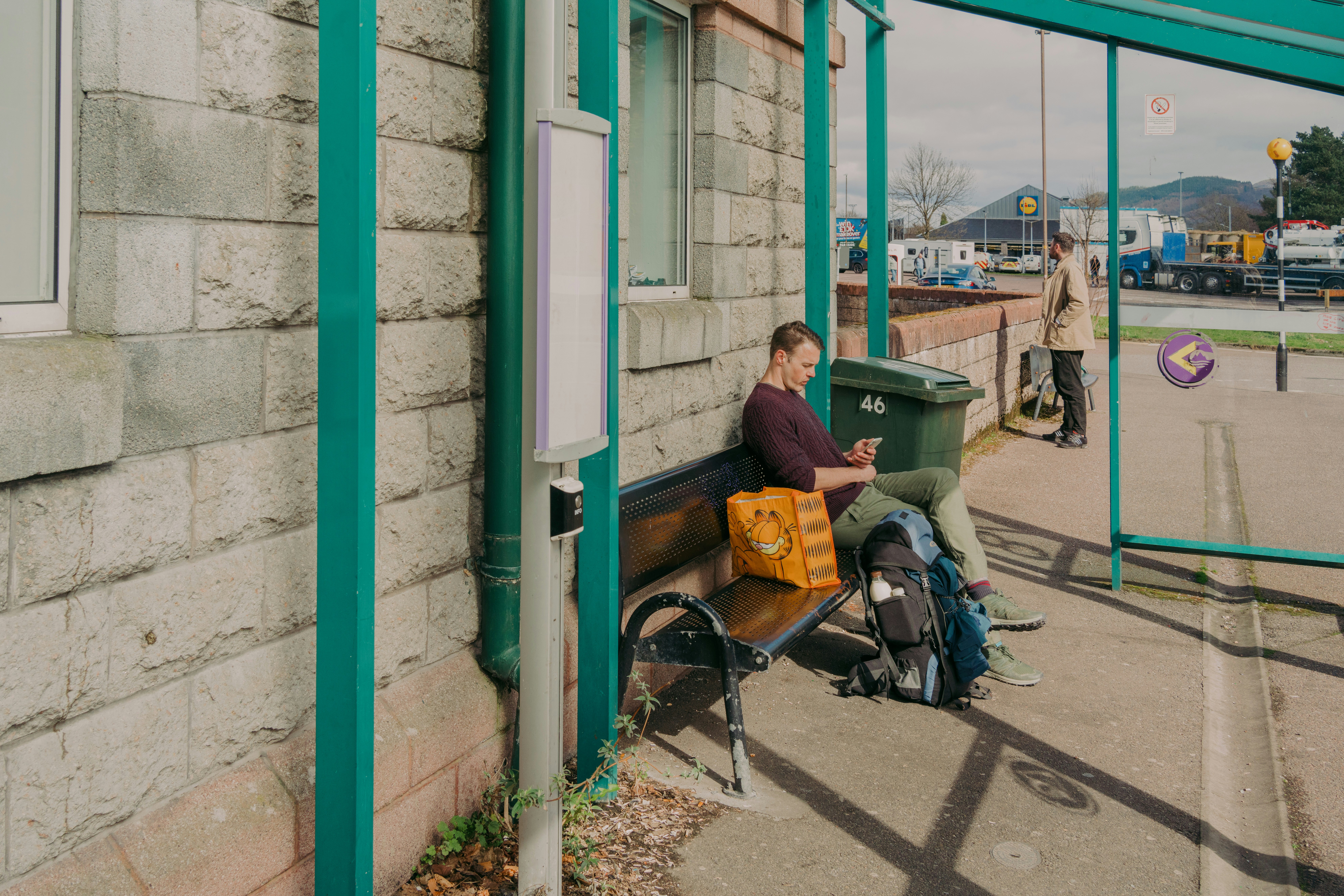Teal-Framed Pause: Quiet Morning at a Small-Town Bus Stop