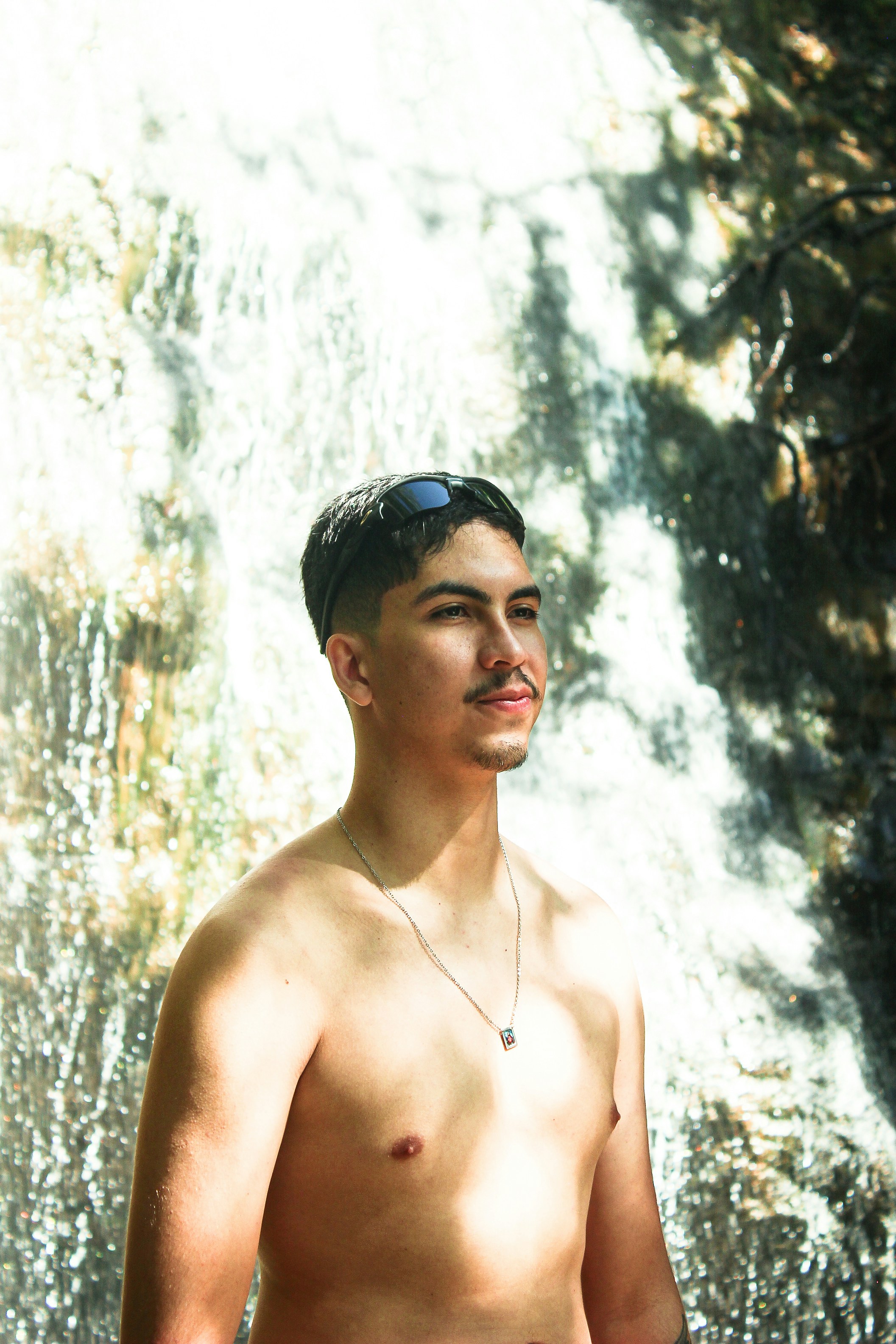 A man poses shirtless in front of a waterfall. photo – Free Aesthetic ...