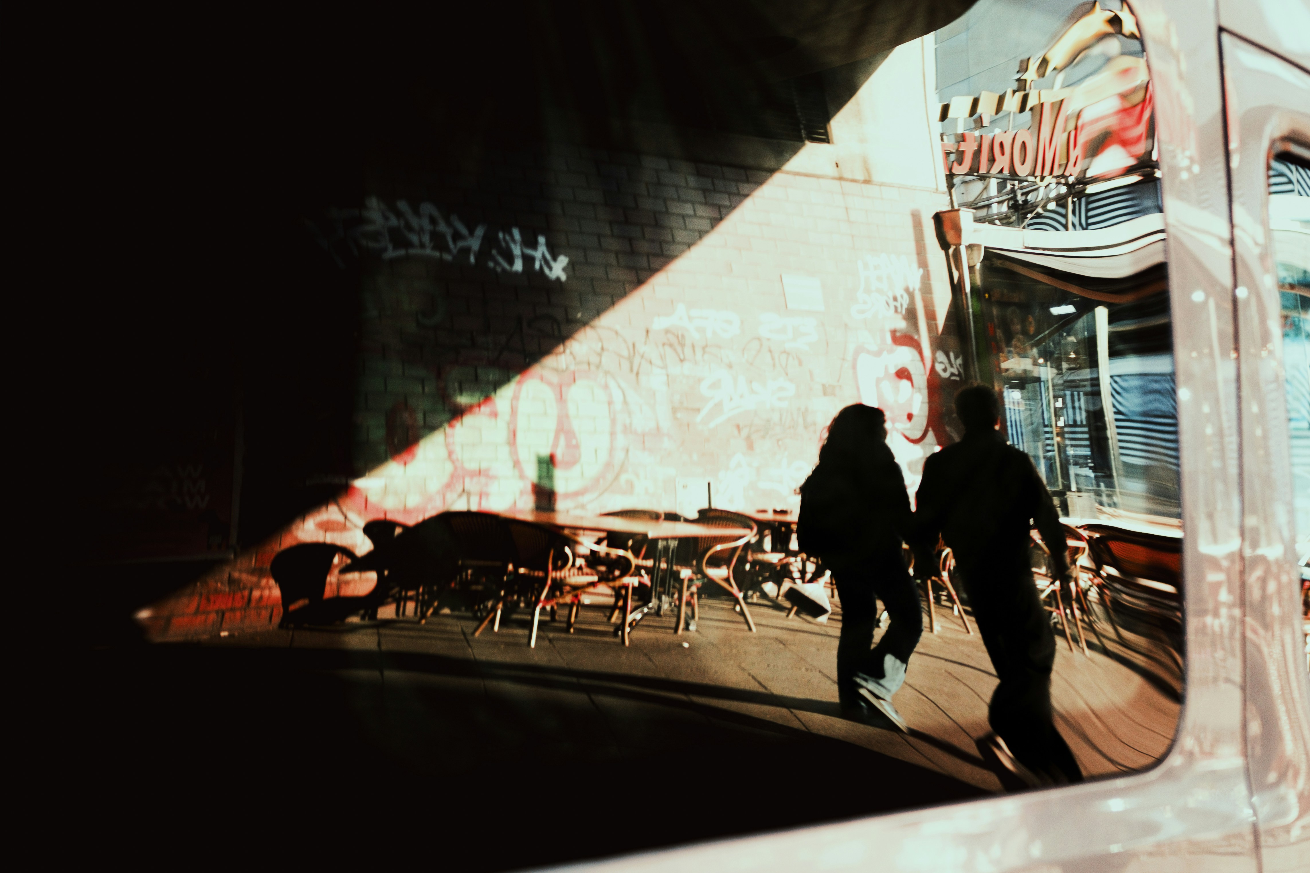 Reflection captures two figures walking down a street. photo – Free ...