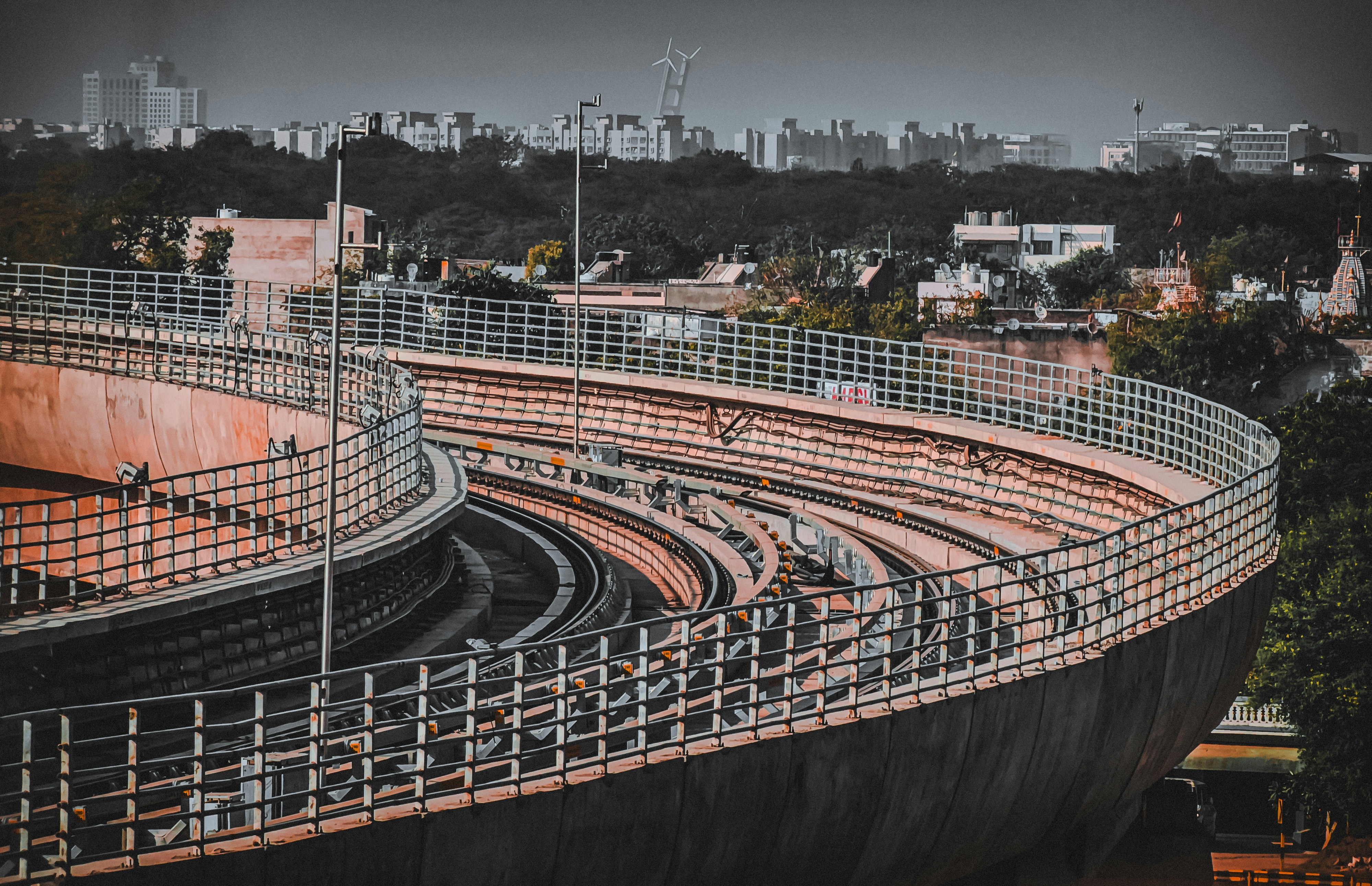 Curved Overpass: Spiral Railings Frame the Distant Skyline