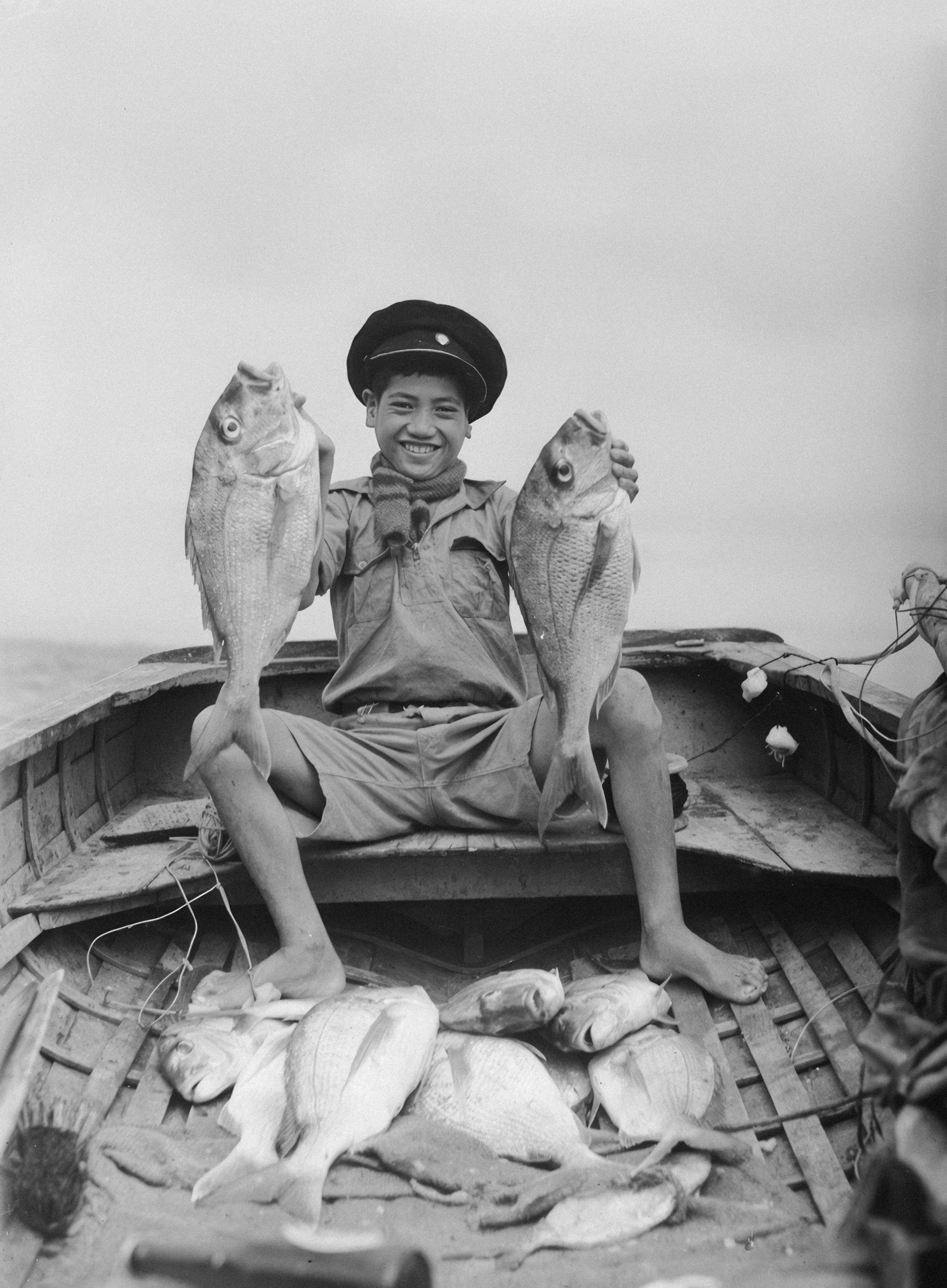 Joyful Catch: A Young Fisherman's Triumph