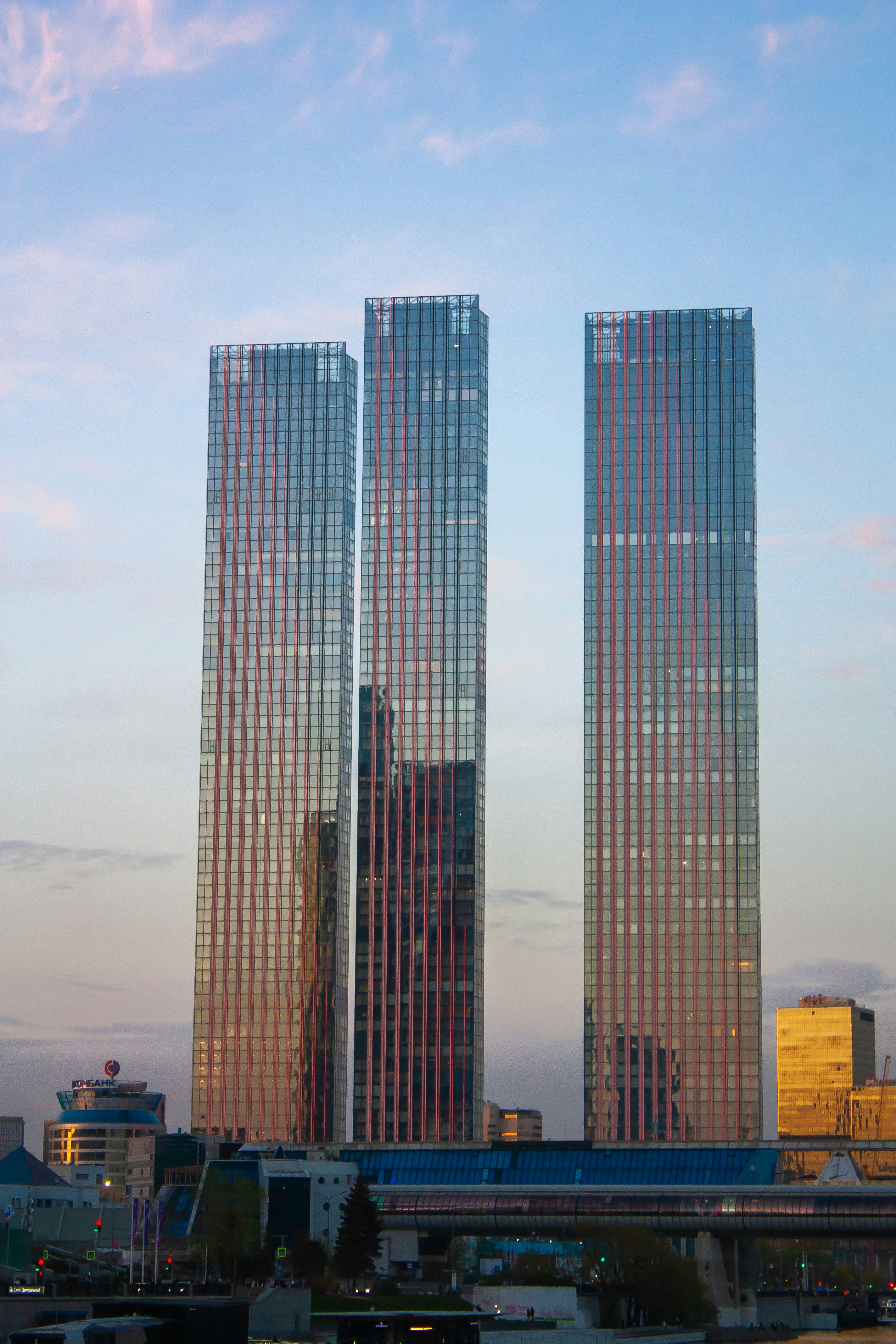 Three skyscrapers stand tall against a sunset sky. photo – Free City ...