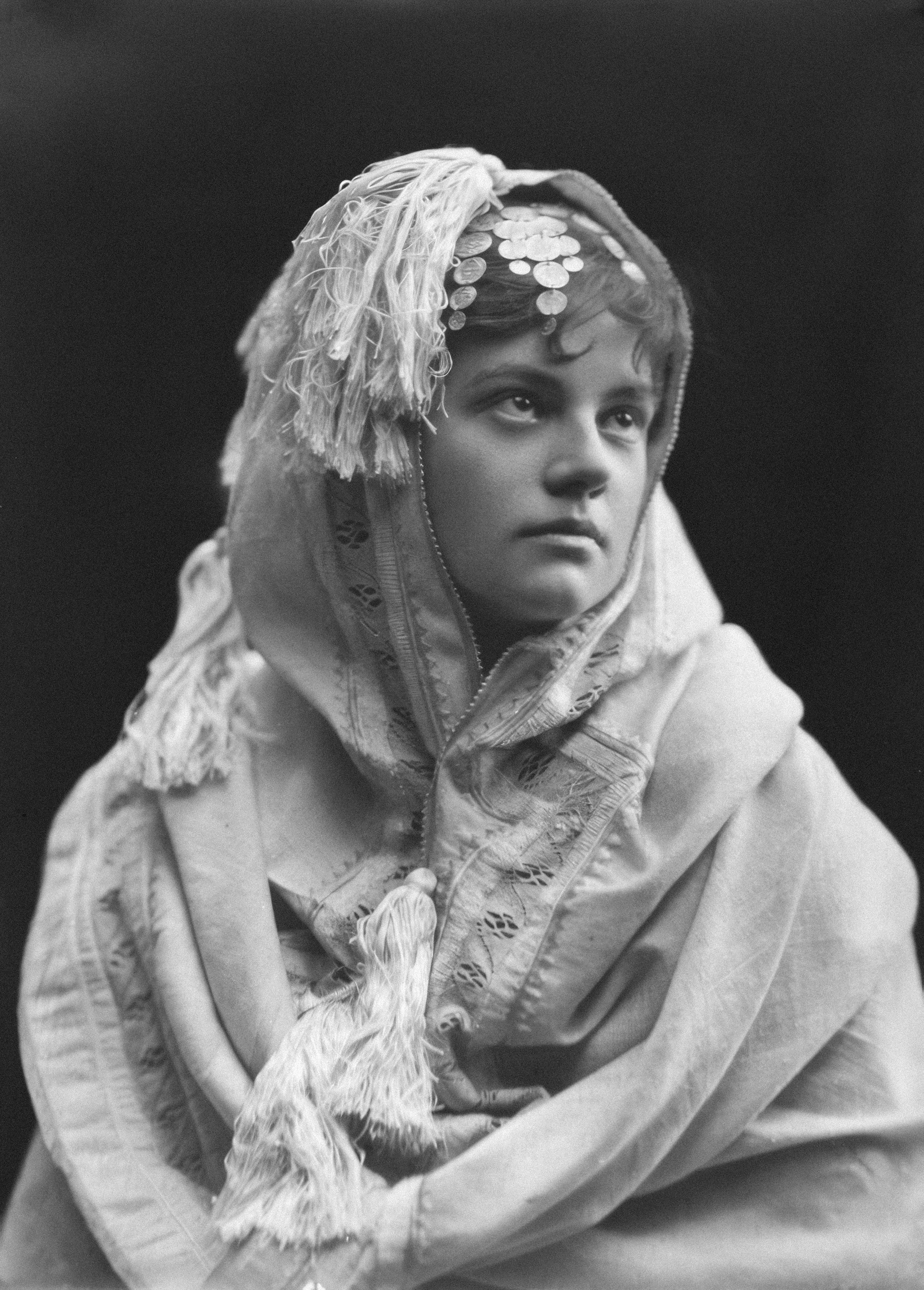 A young woman wears a traditional head covering. photo – Free Film photography Image on Unsplash