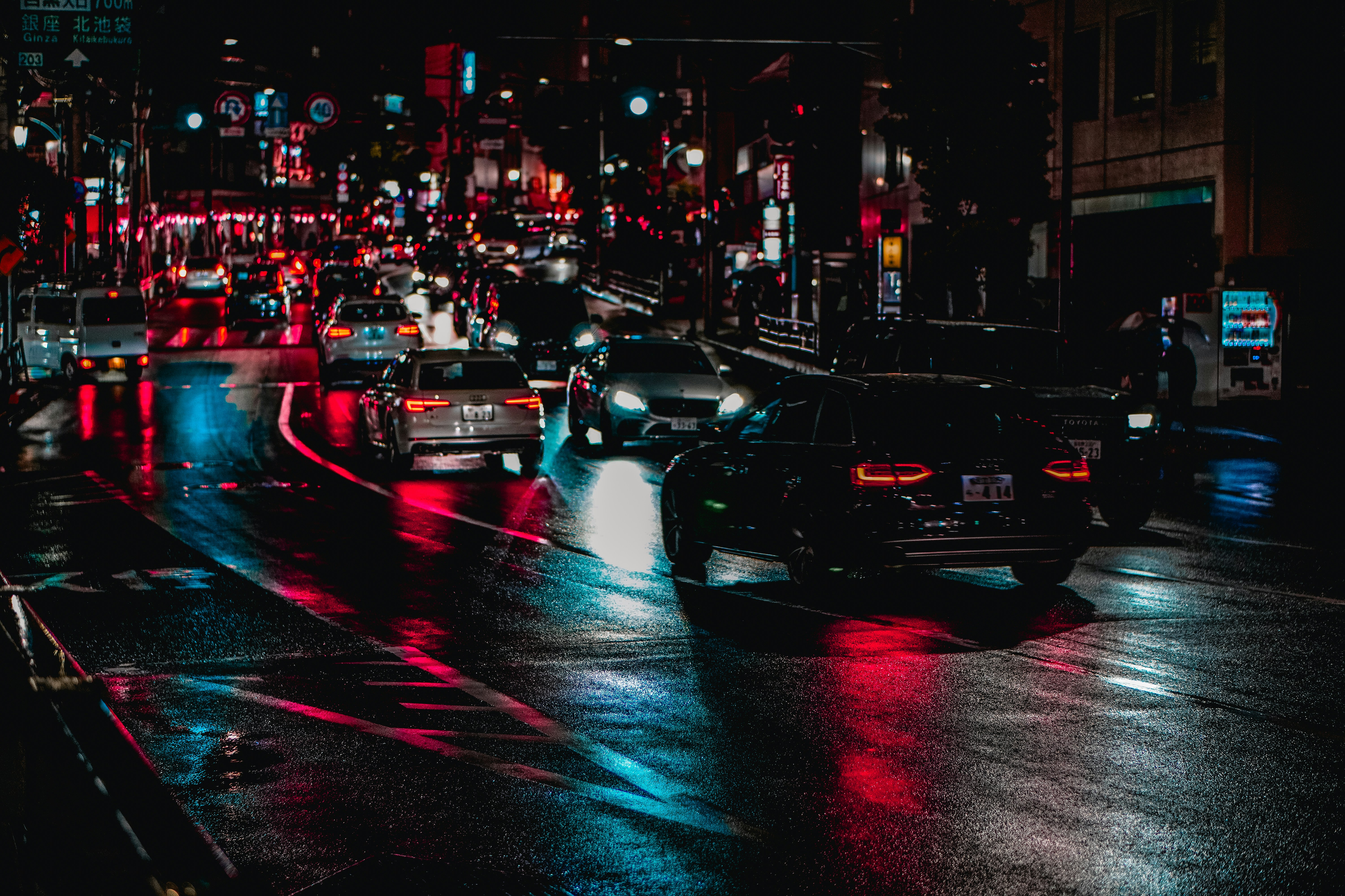 Nighttime cityscape with vehicle headlights and neon lights. photo ...