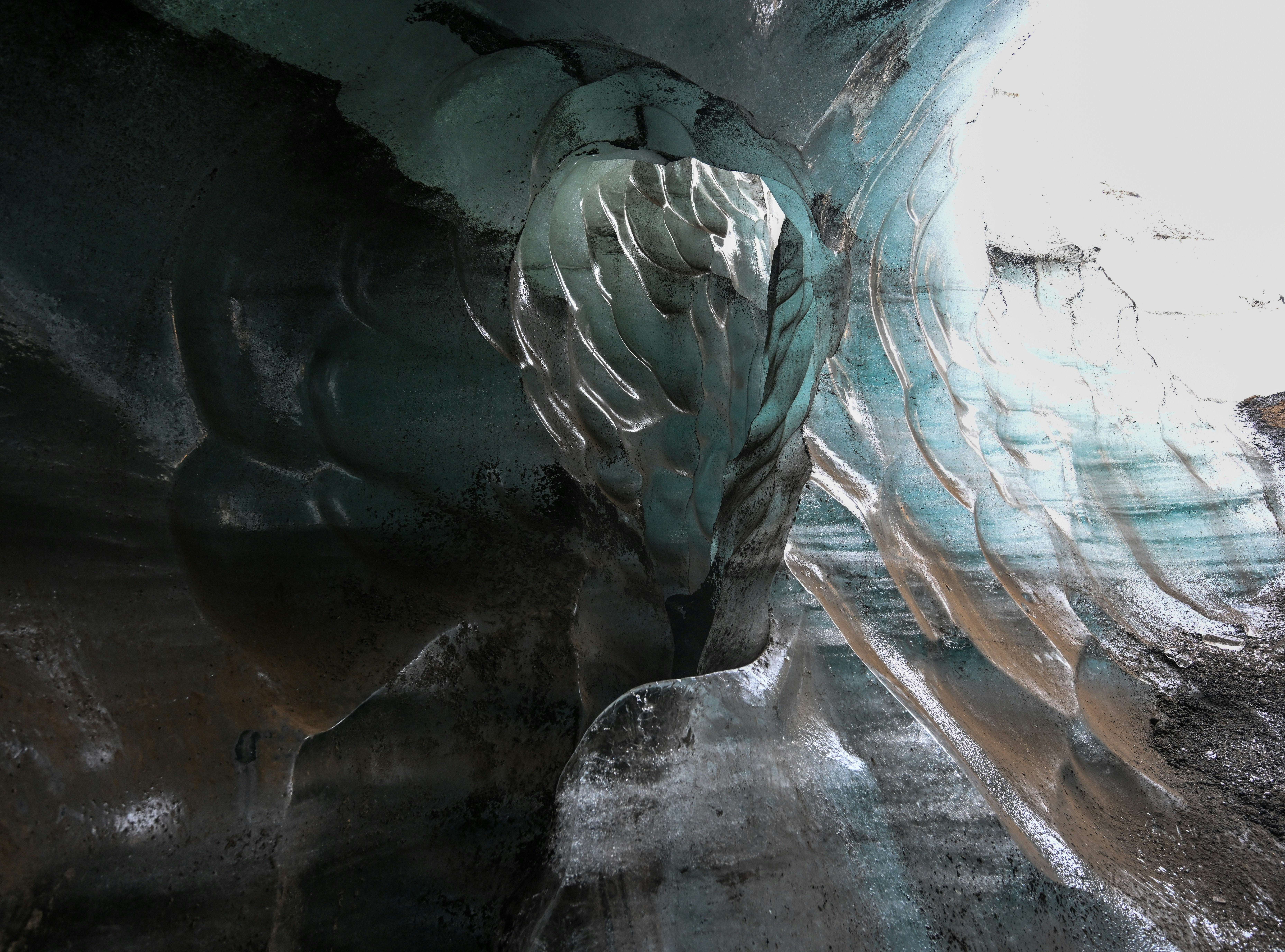 Inside a glacial ice cave, beautiful and blue.