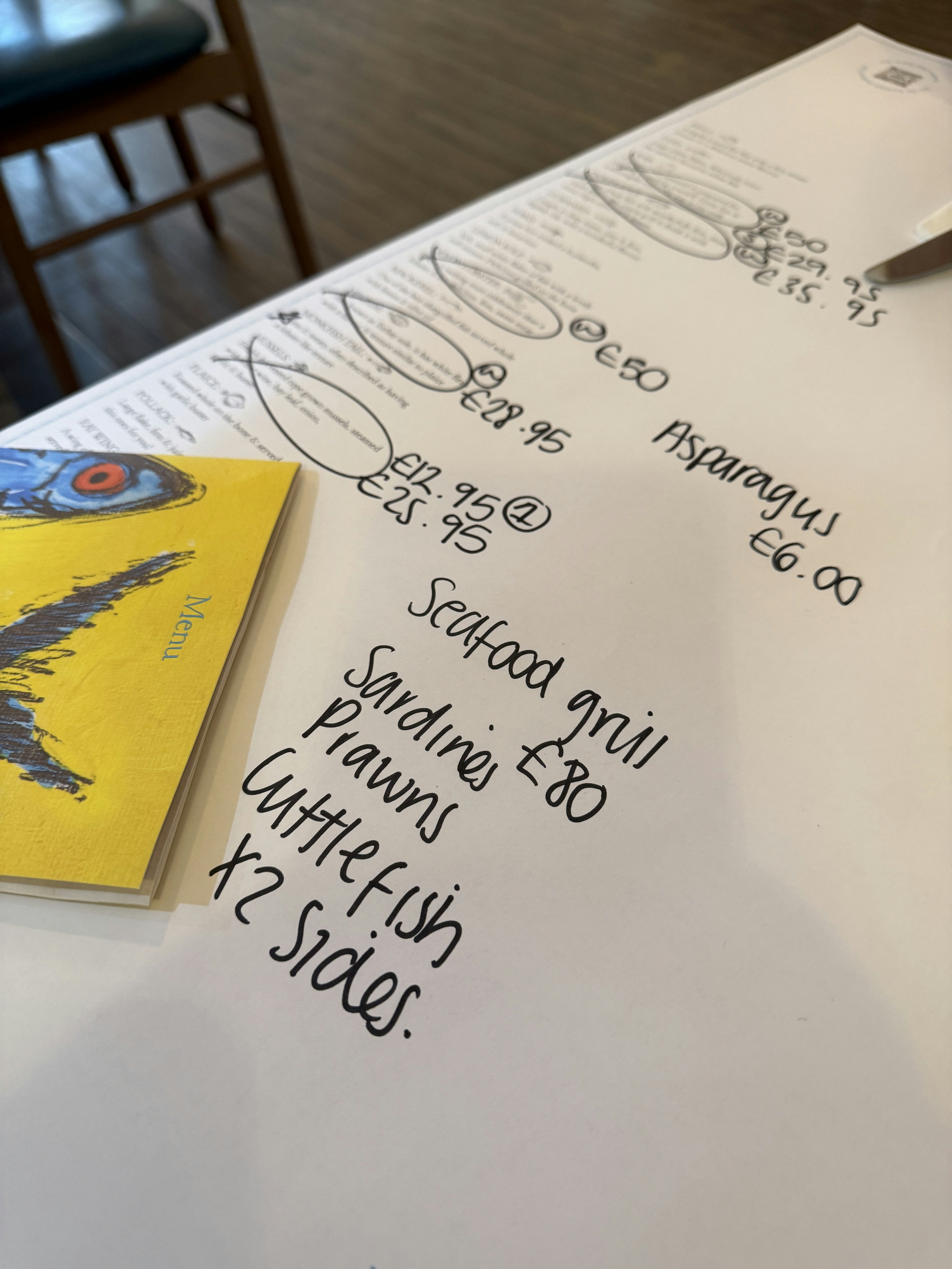 Yellow Book on a White Table Anchors a Menu Moment