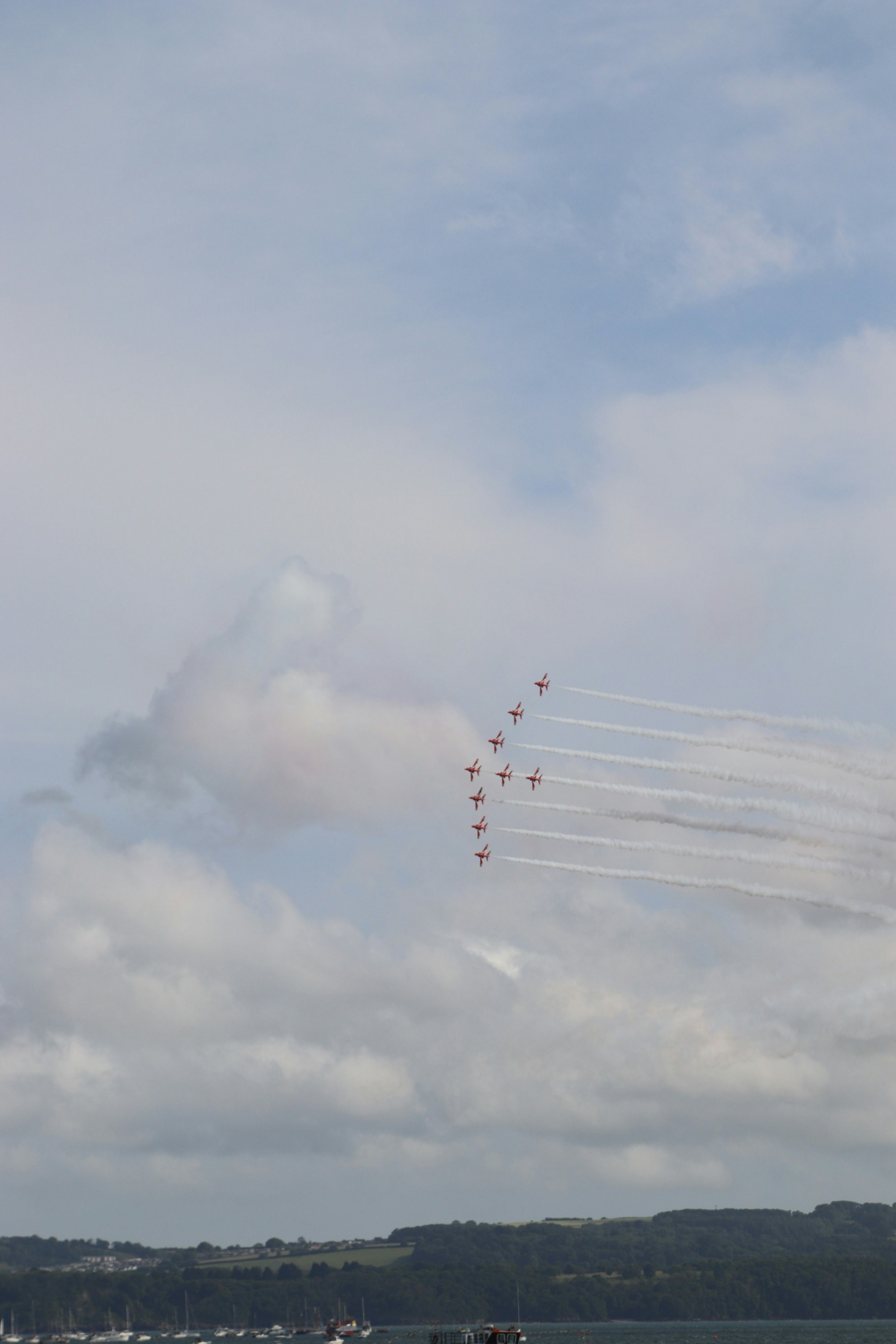Red jets perform an aerial display in the cloudy sky. photo – Free Red ...