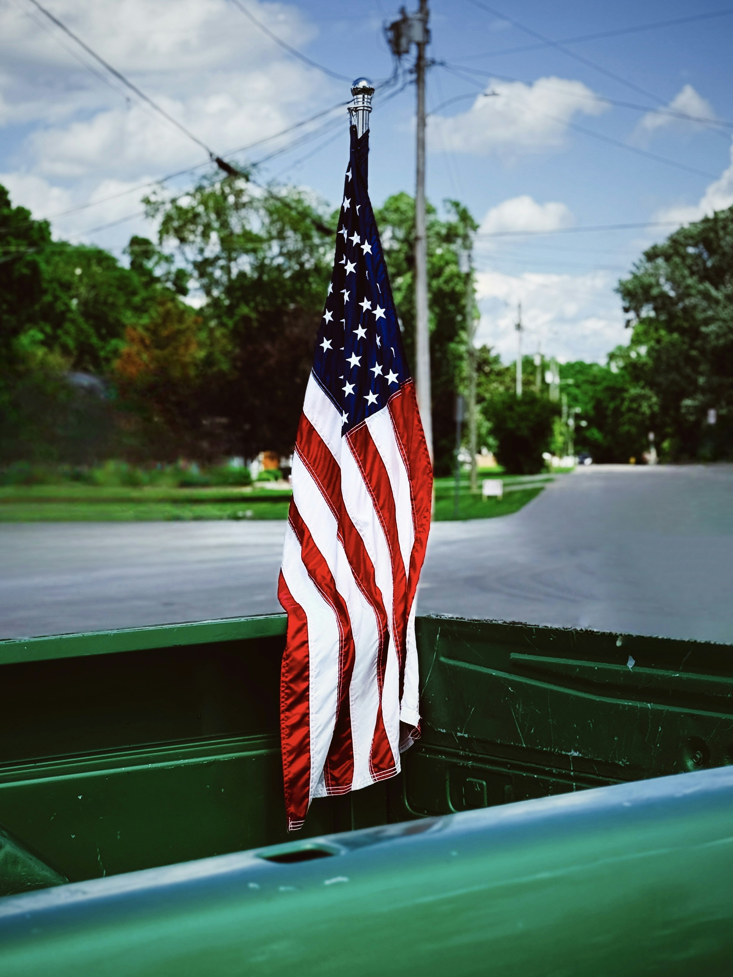 American flag hangs out of a green truck. photo – Free America Image on ...